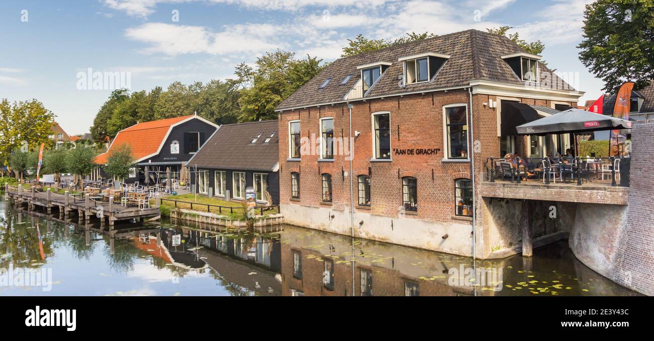 Panorama of a restaurant in a historic building at the canal in Elburg ...