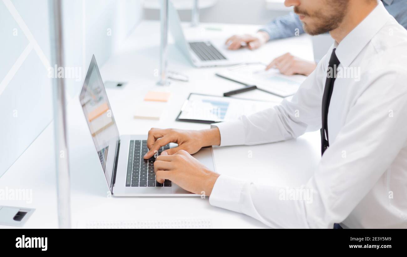 business man working on a laptop in the office Stock Photo - Alamy