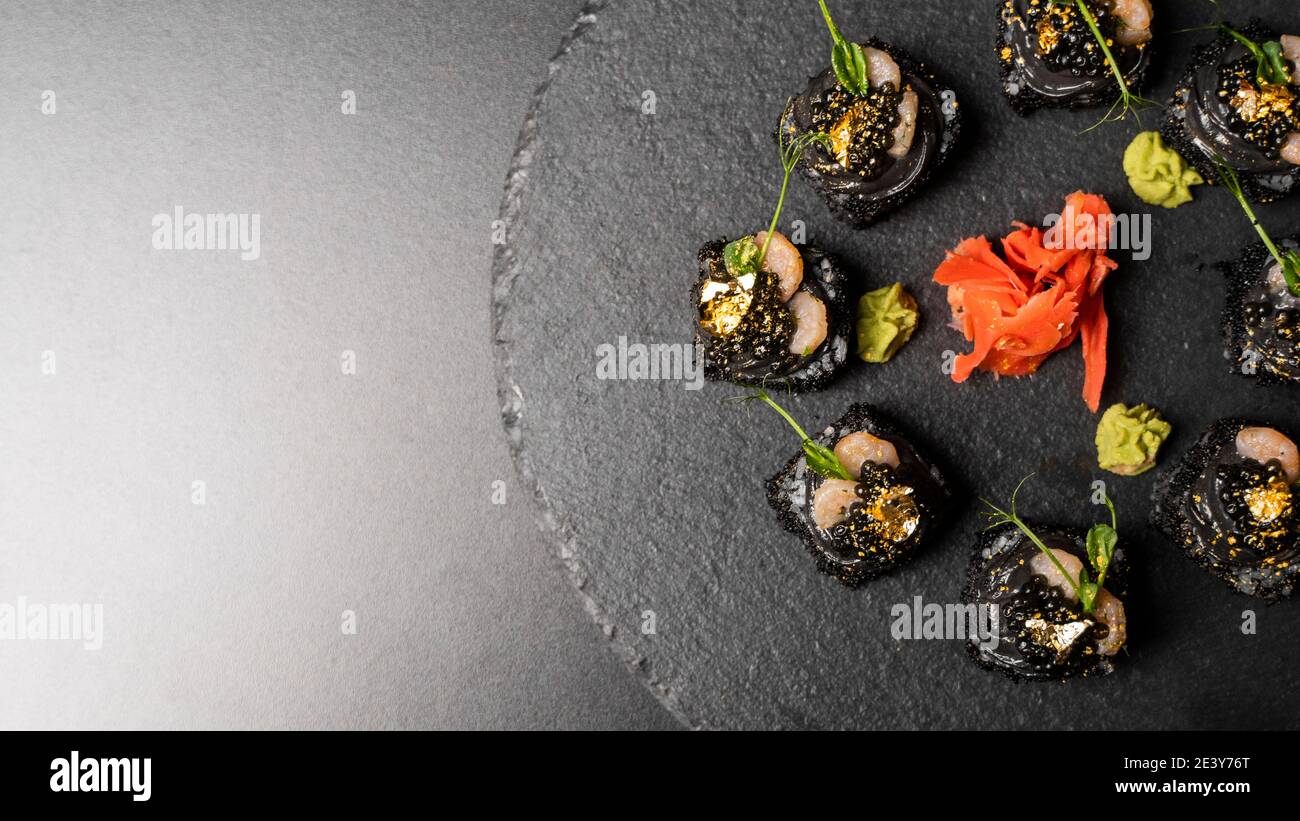 Sushi roll with nori, black rice, crab meat, cucumber, avocado, smoked ...