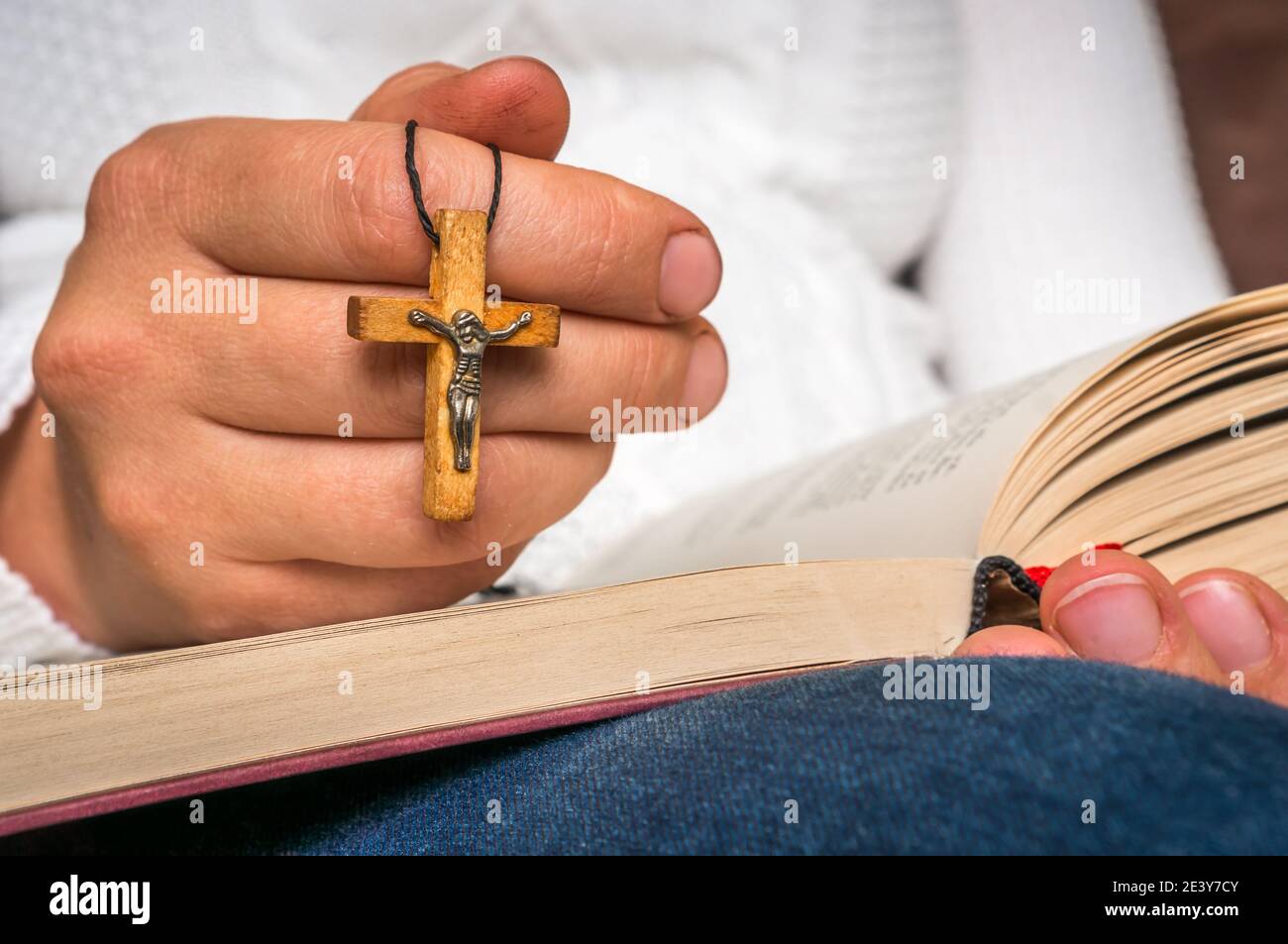 Christian woman with wooden cross reading a holy Bible - religious ...