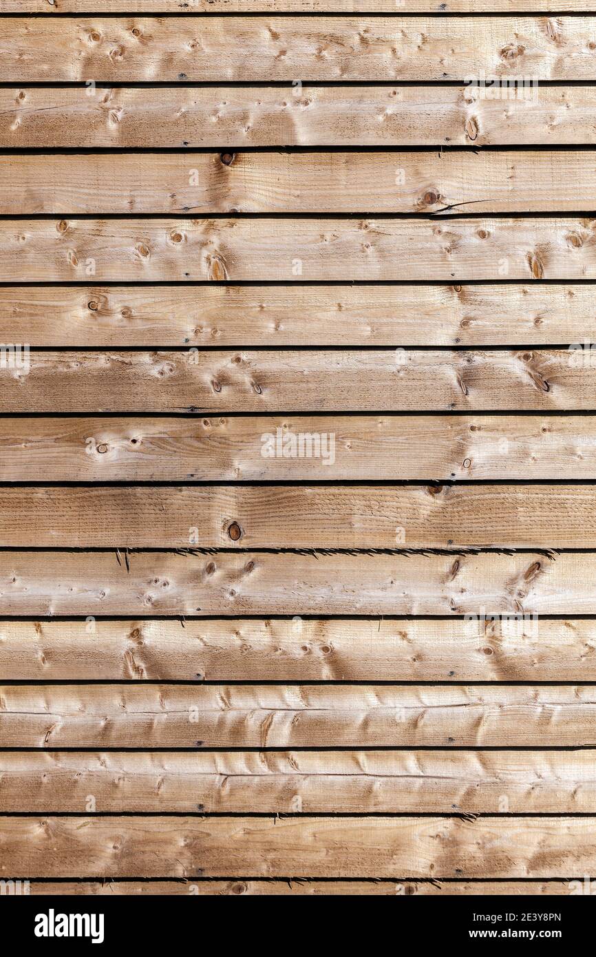 New modern brown wooden fence panel background with rough knotted grain ...