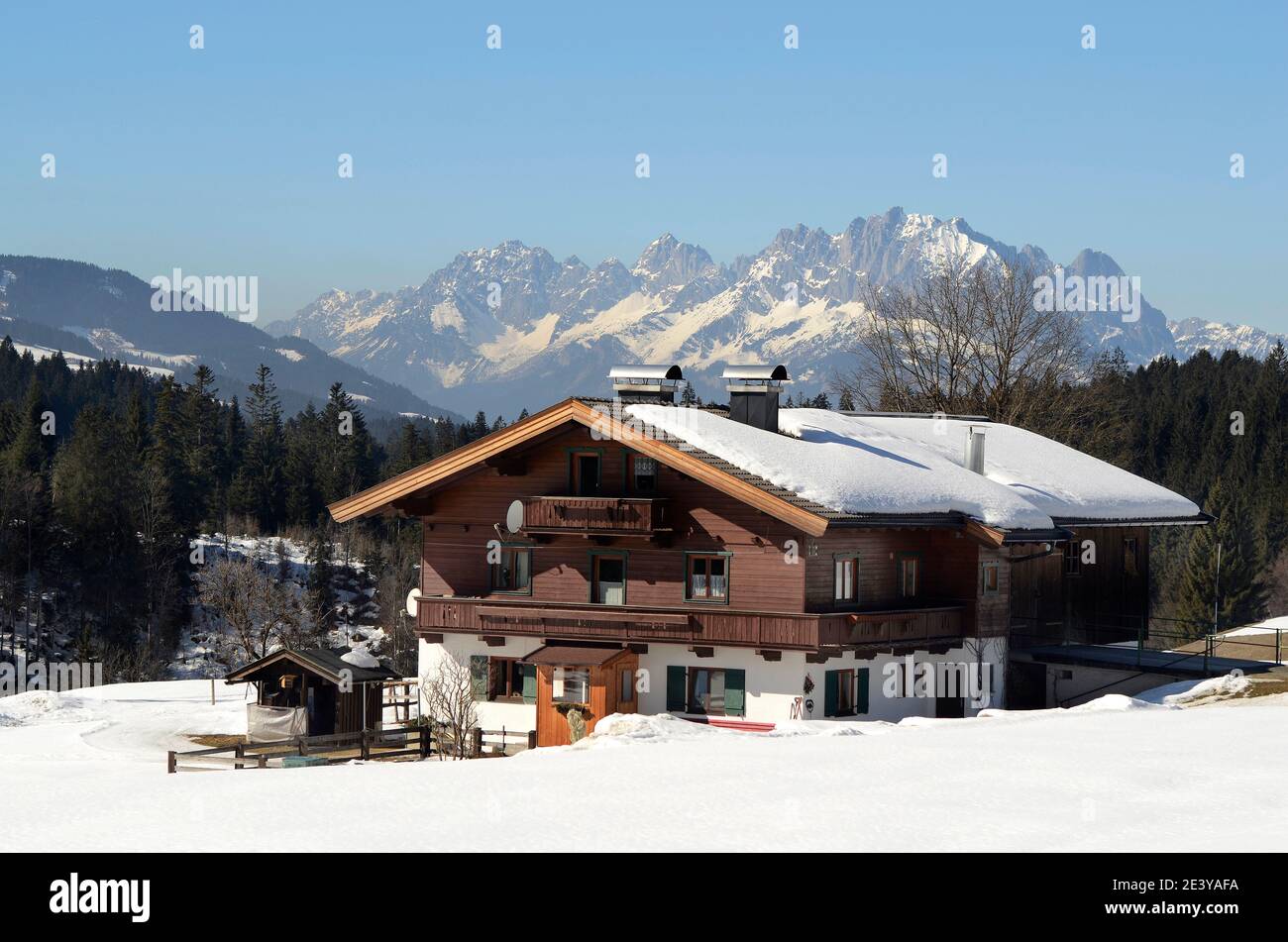 Austria, farmhouse built in traditional Tyrolean style in snowy ...