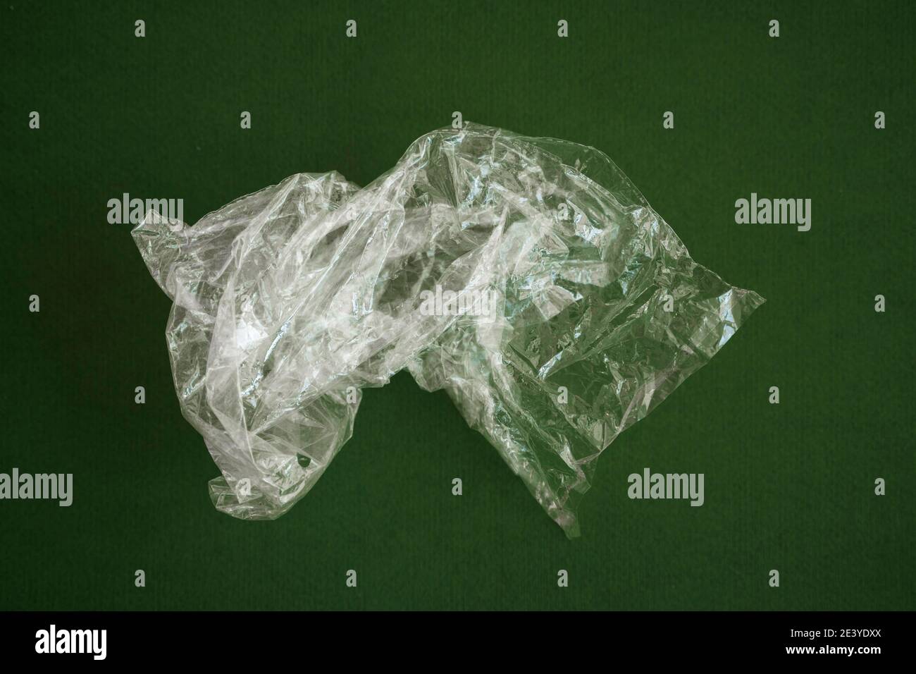 Crumpled plastic polyethylene bag on a green background. Contamination ...