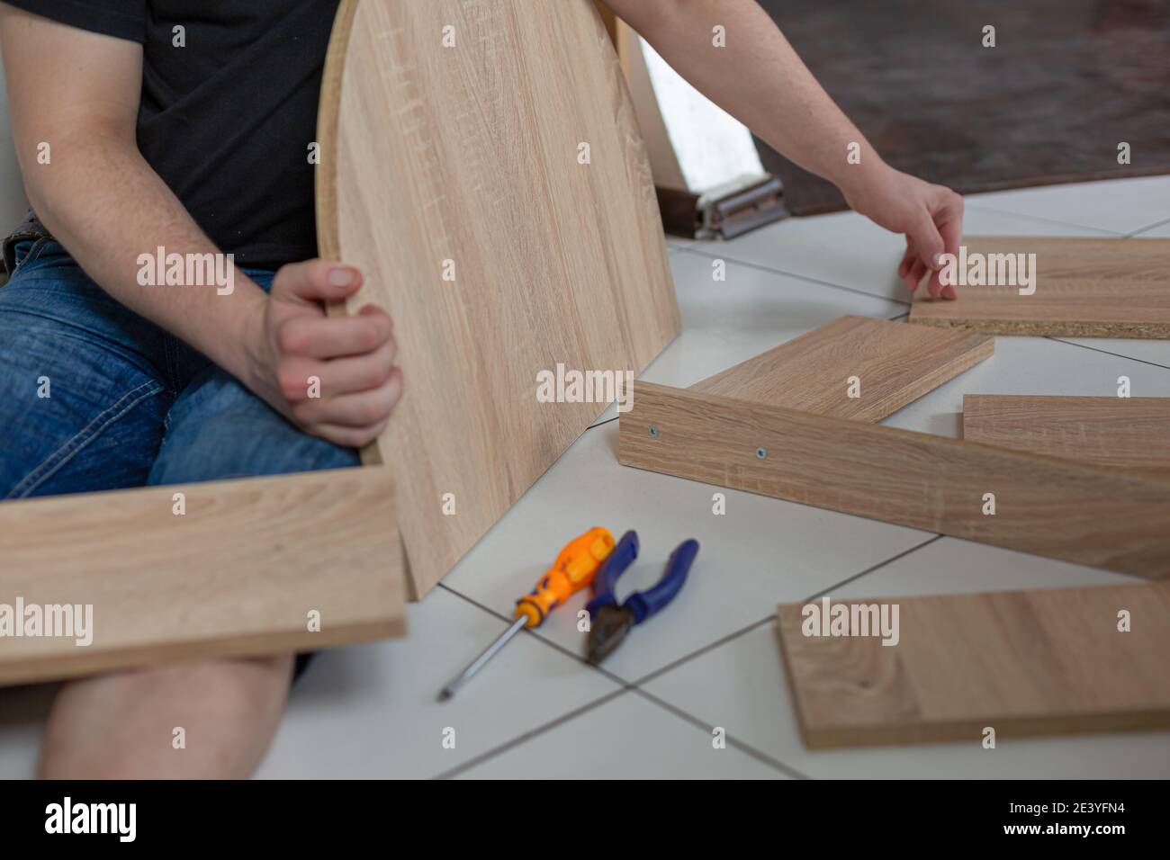Assembling of furniture with his own hands at home Stock Photo - Alamy