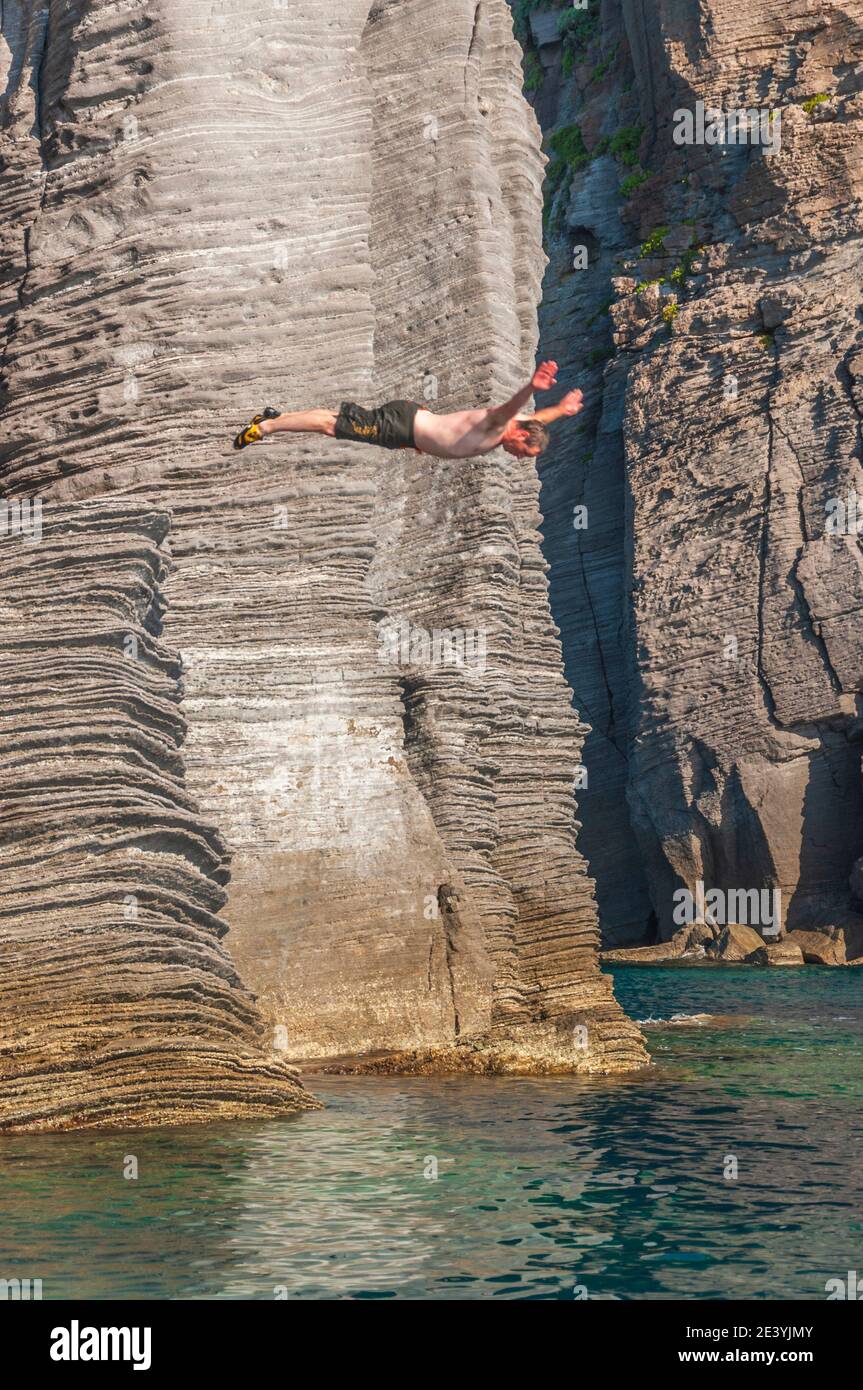 Man jumping from cliff Stock Photo - Alamy