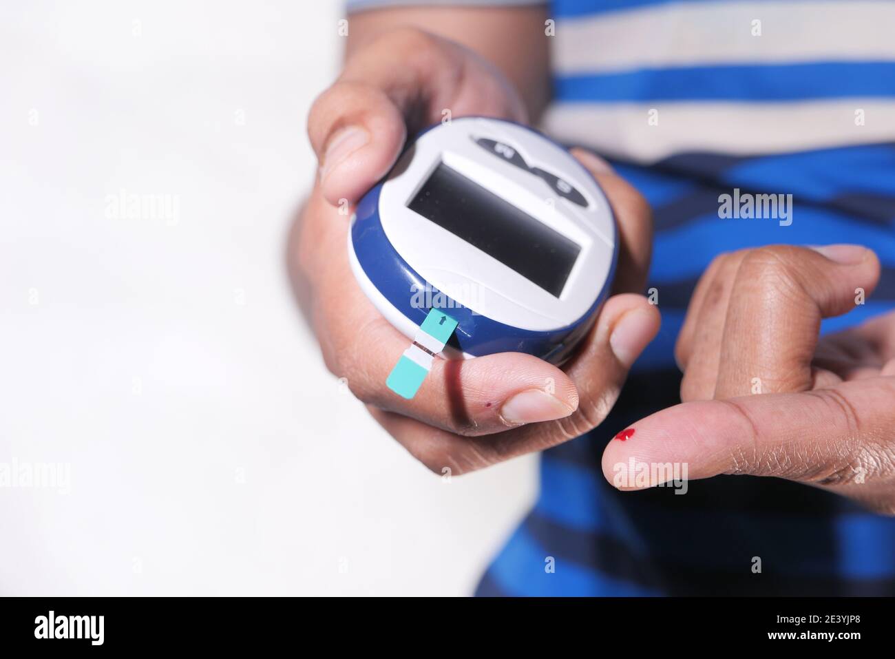 close up of man's hand diabetic checking blood sugar level isolated ...