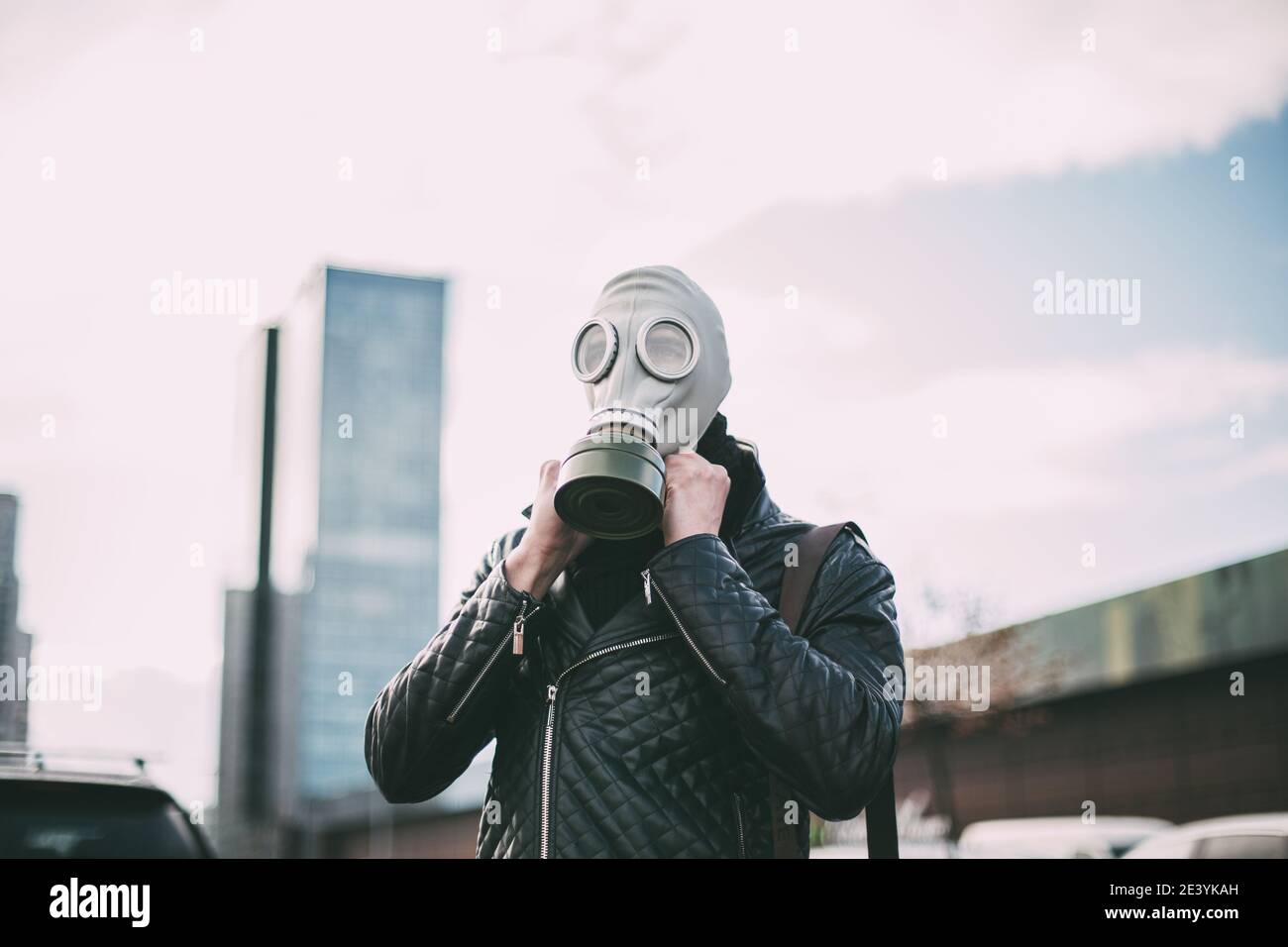 young man wearing a gas mask on a city street Stock Photo - Alamy