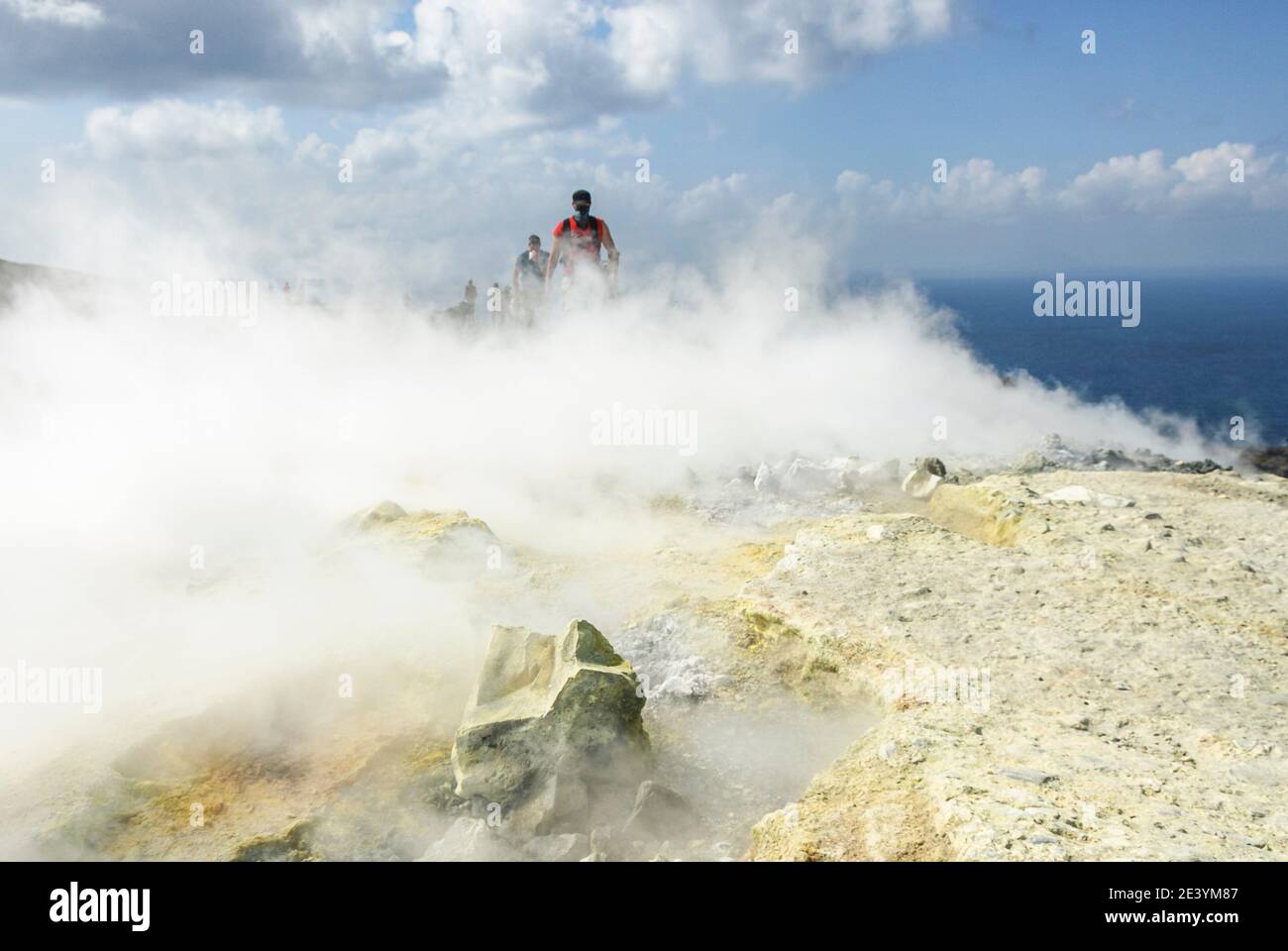 Hikers on the ridge of Volcano crater Stock Photo - Alamy