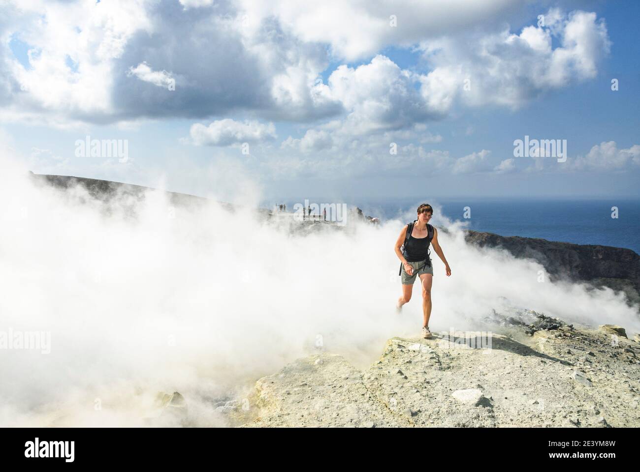 Hikers on the ridge of Volcano crater Stock Photo - Alamy