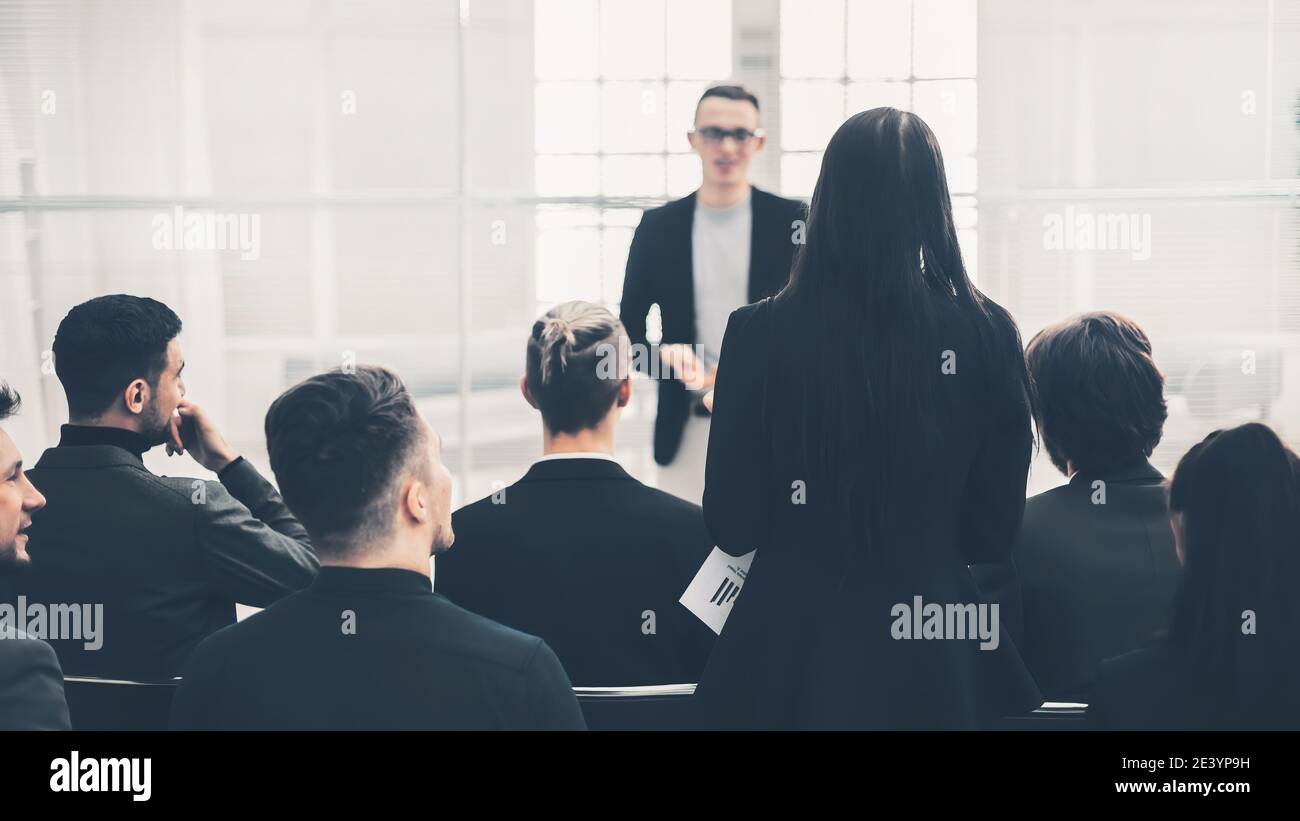 speaker by asking questions during the seminar Stock Photo - Alamy