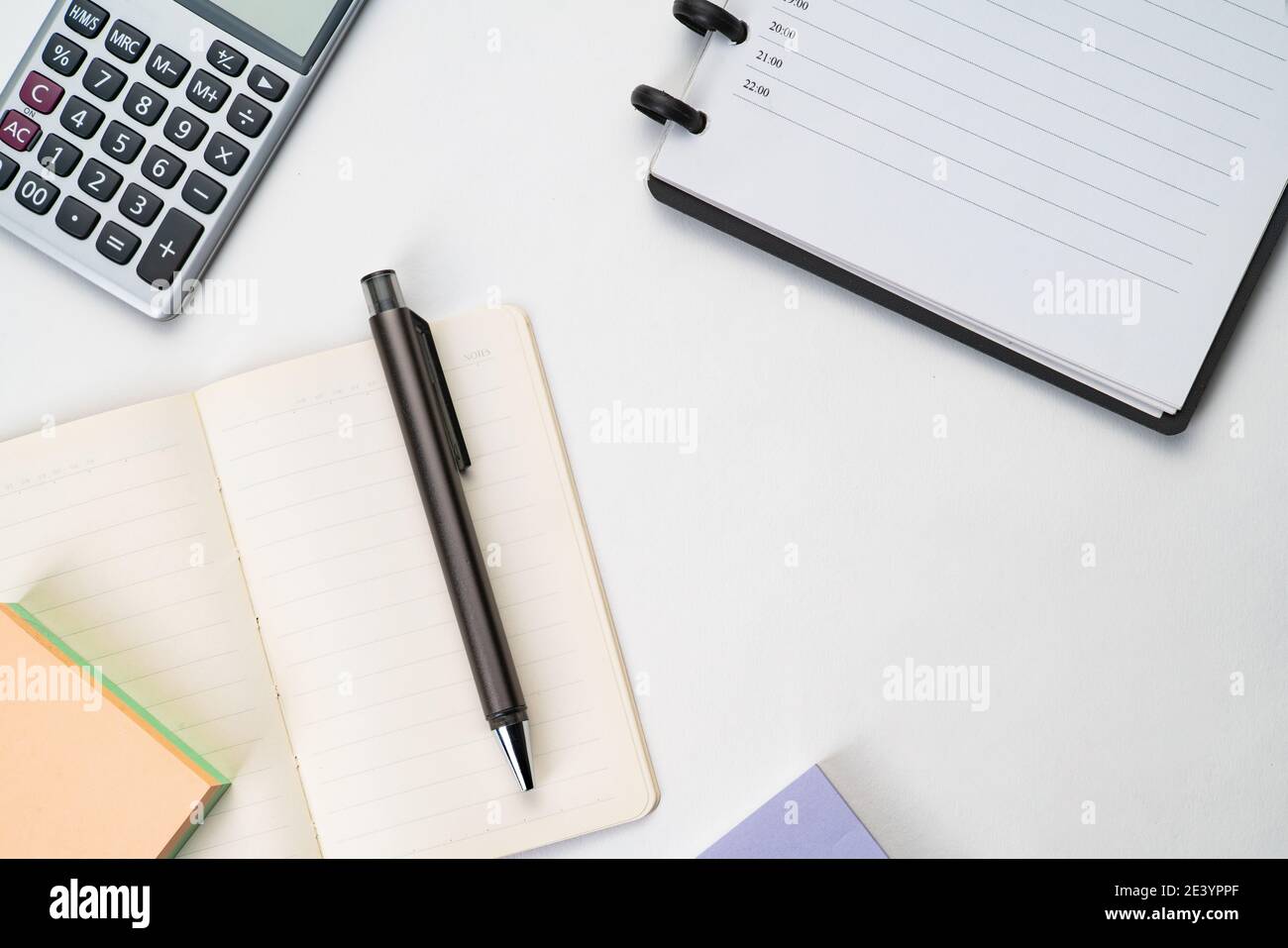 Topview of notebook with pen, calculator and sticky note Stock Photo ...