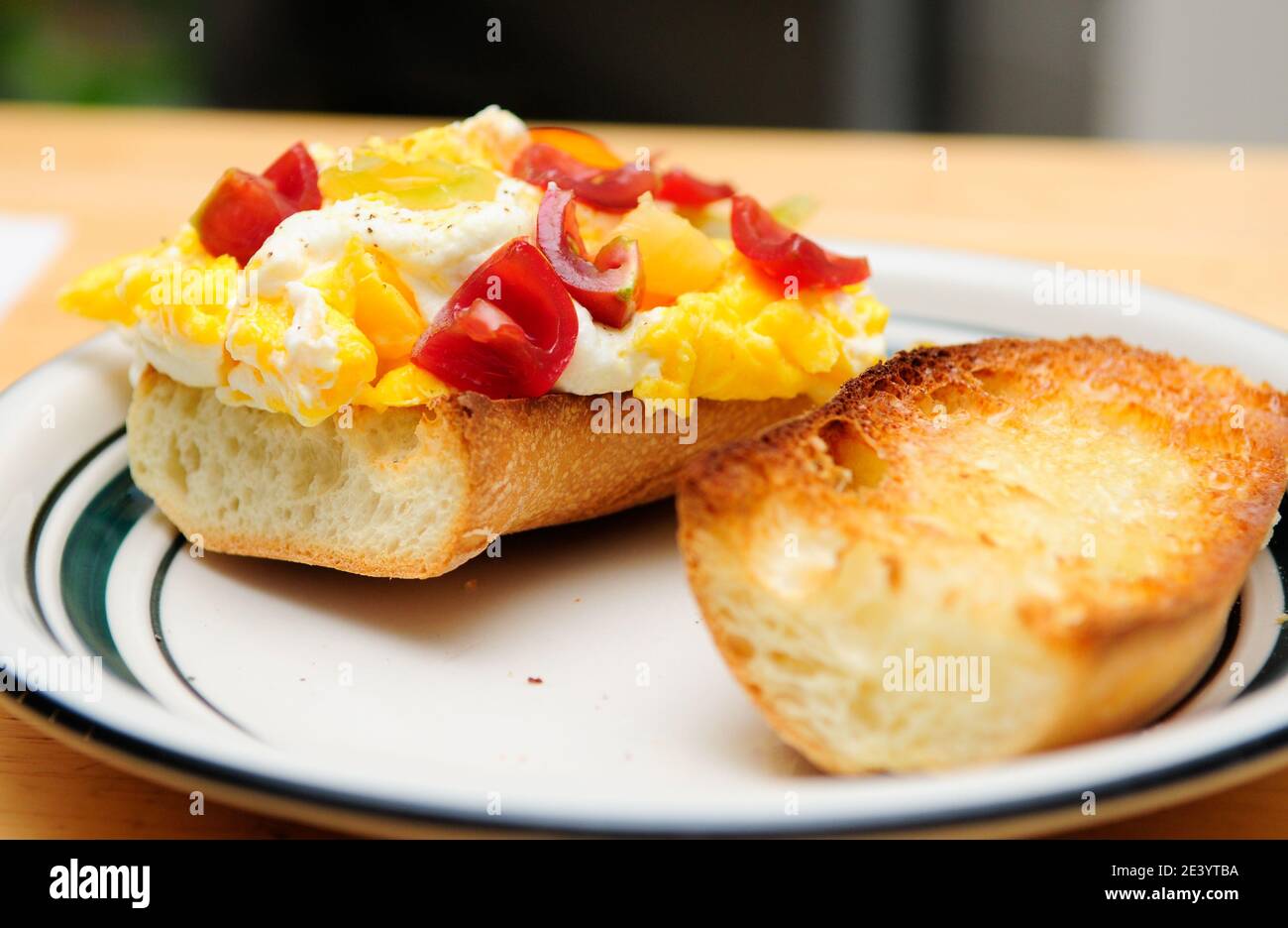 tomato with egg breakfast bun with melted goat cheese Stock Photo - Alamy