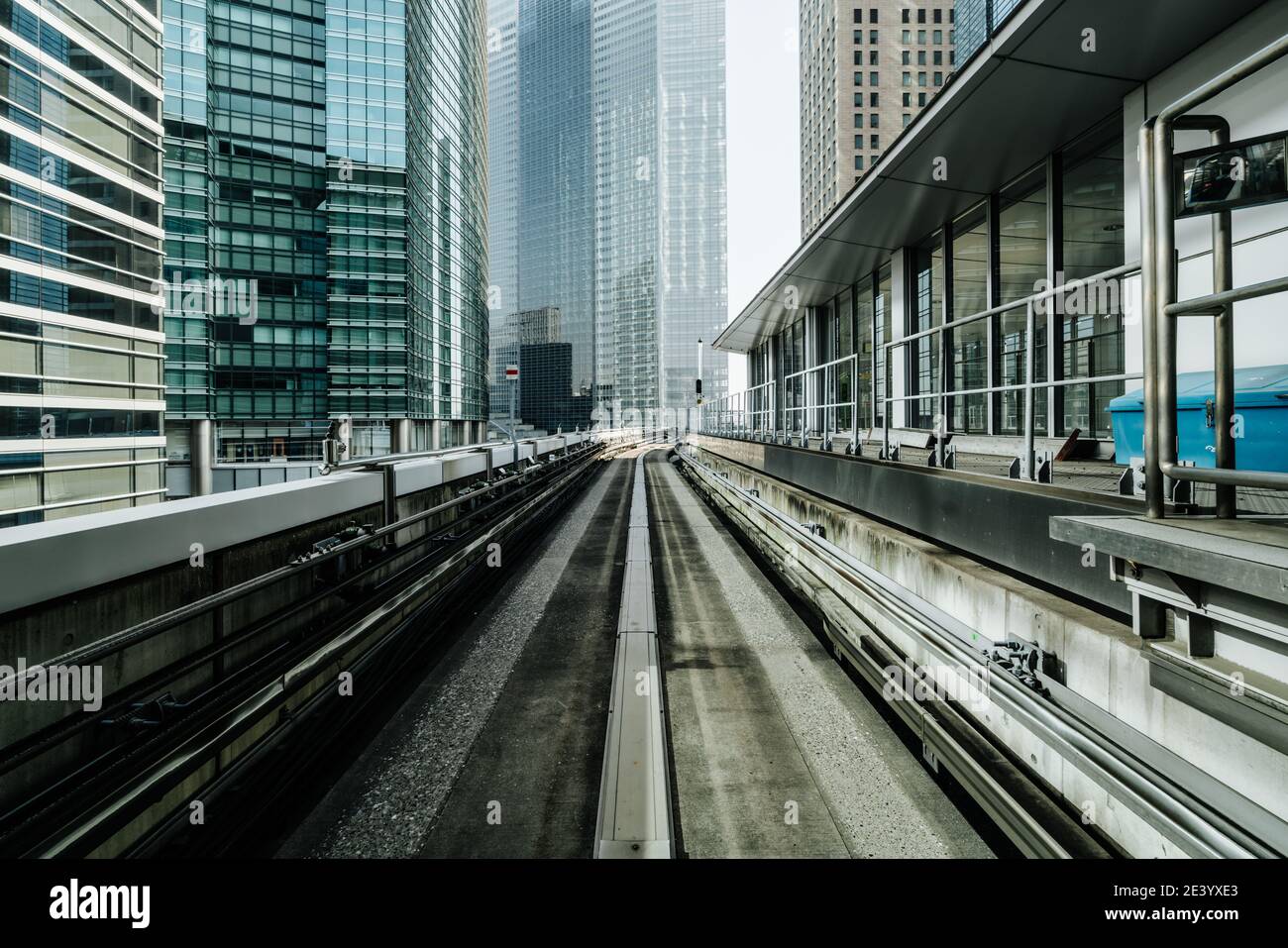 Front view of train in modern city. Straight rail with city buildings ...