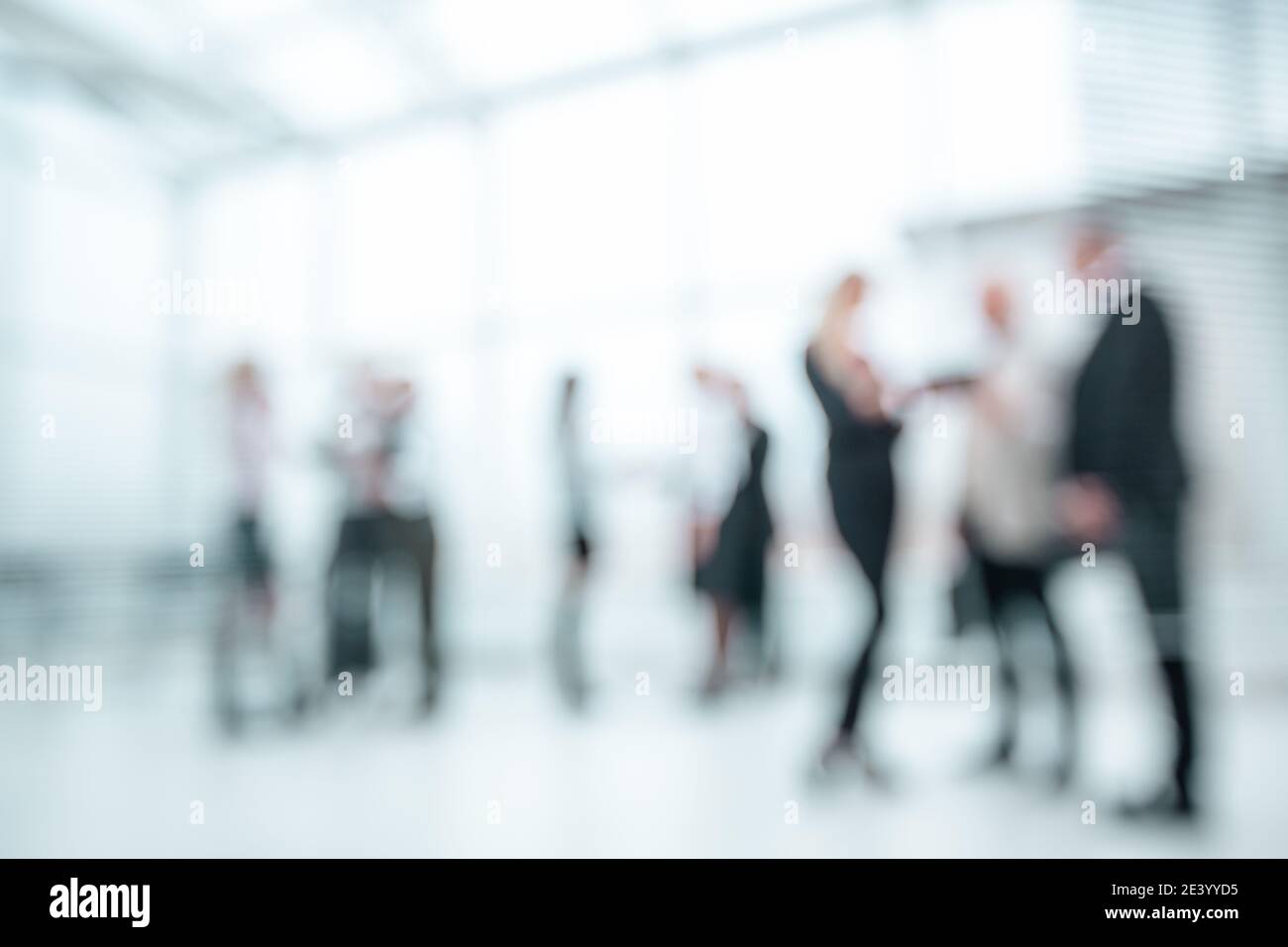 background image of company employees standing in the office lobby ...