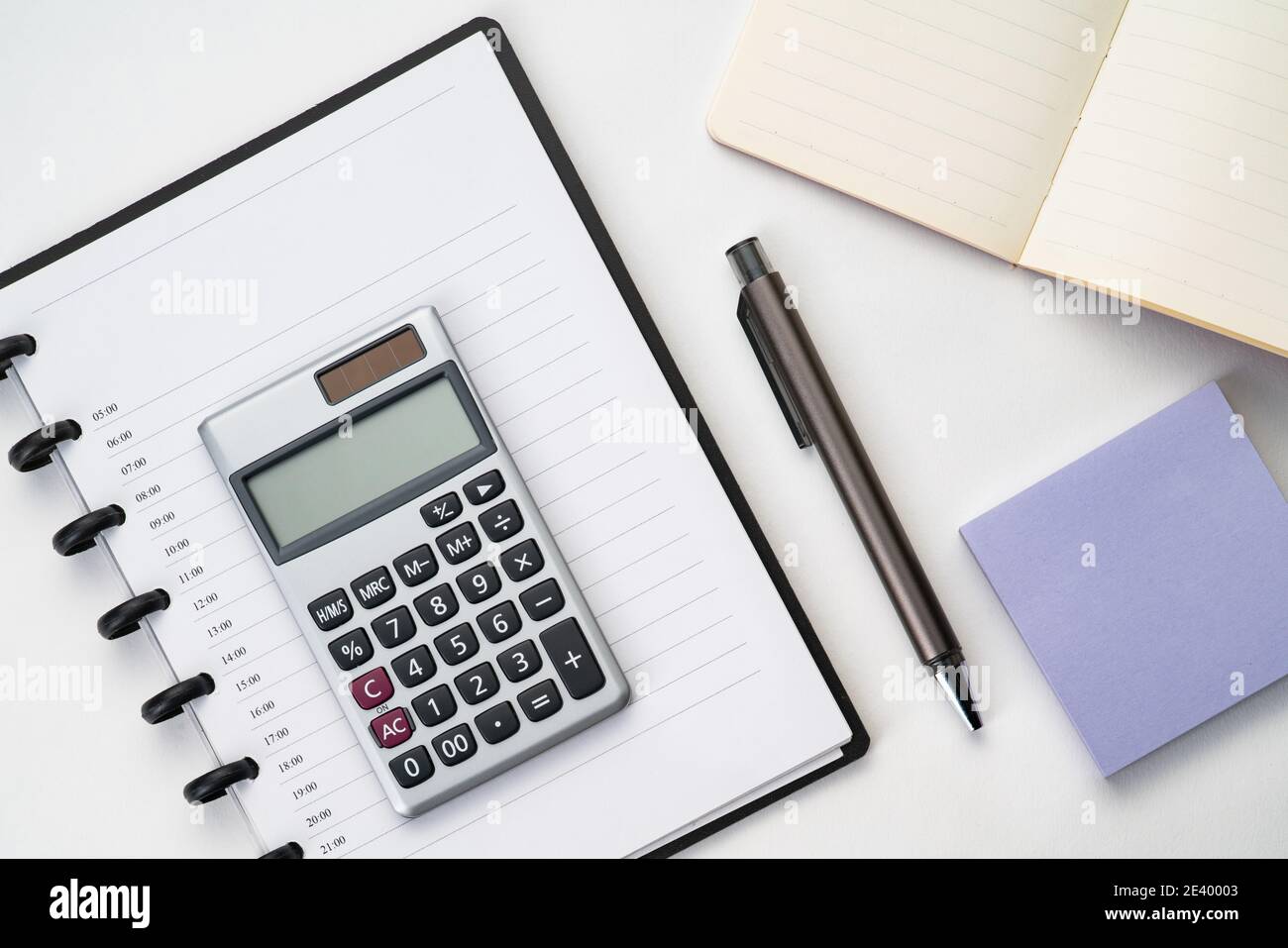 Topview of notebook with pen, calculator and sticky note Stock Photo ...