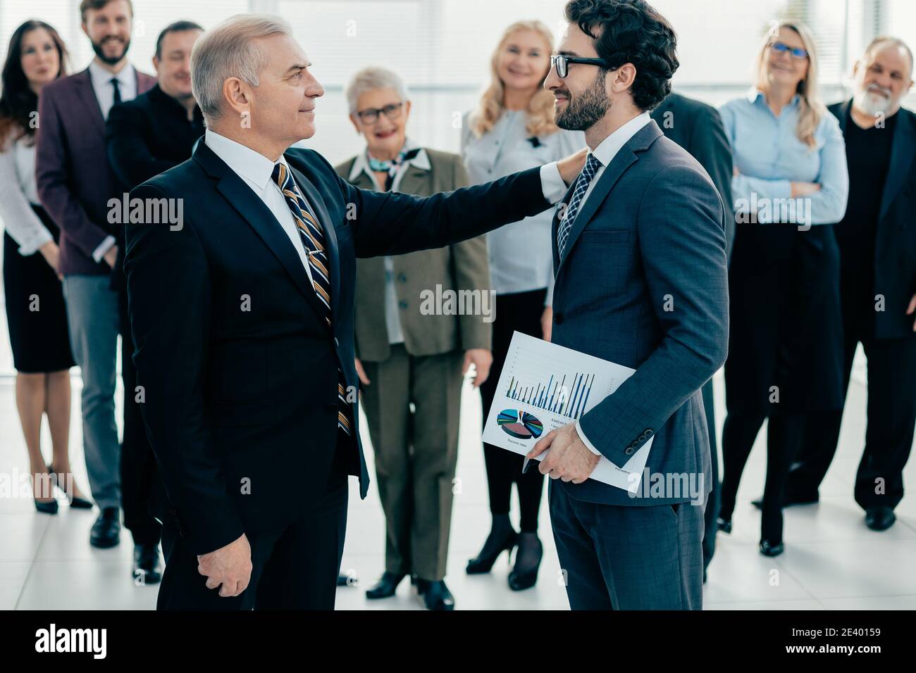 Manager congratulating the best employee at the meeting Stock Photo - Alamy
