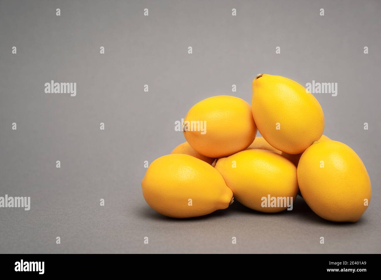 ripe and yellow lemons on grey background Stock Photo - Alamy