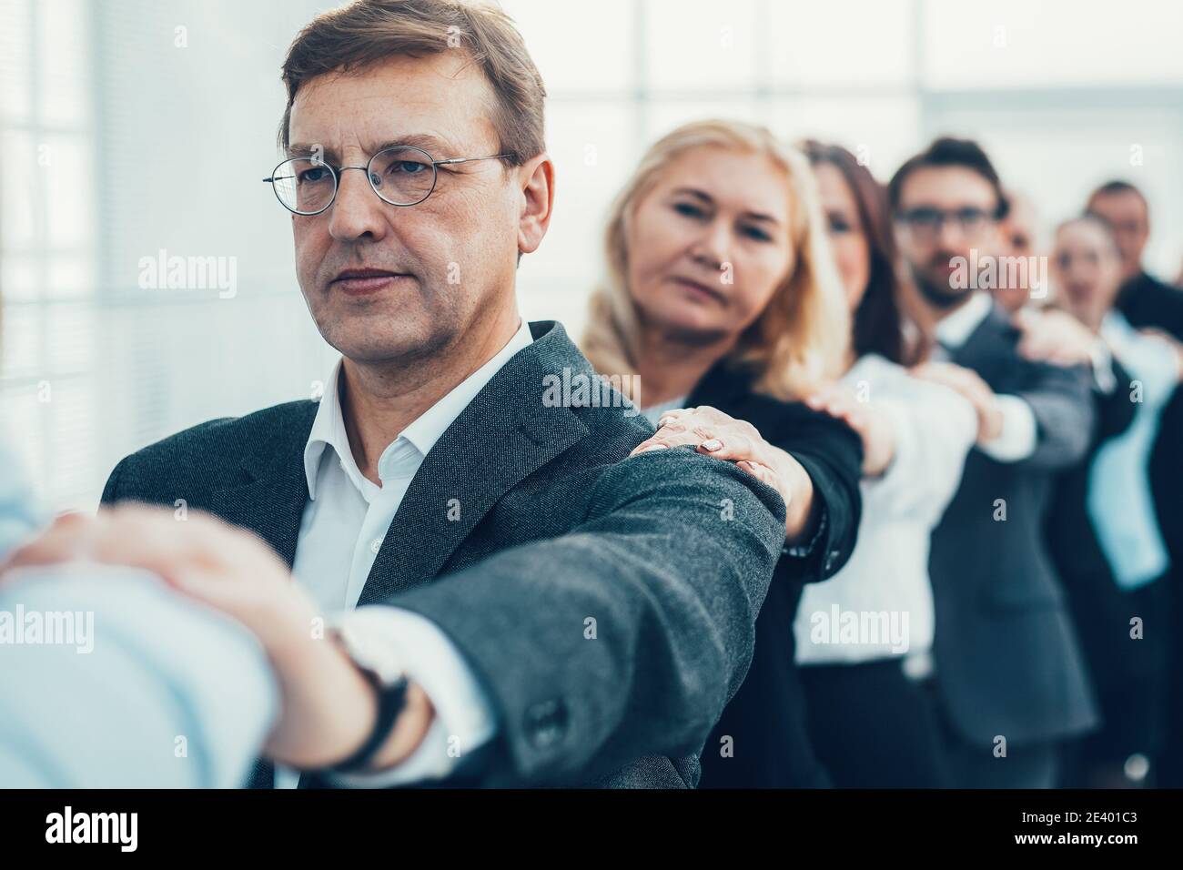 group of serious business people standing behind each other Stock Photo ...