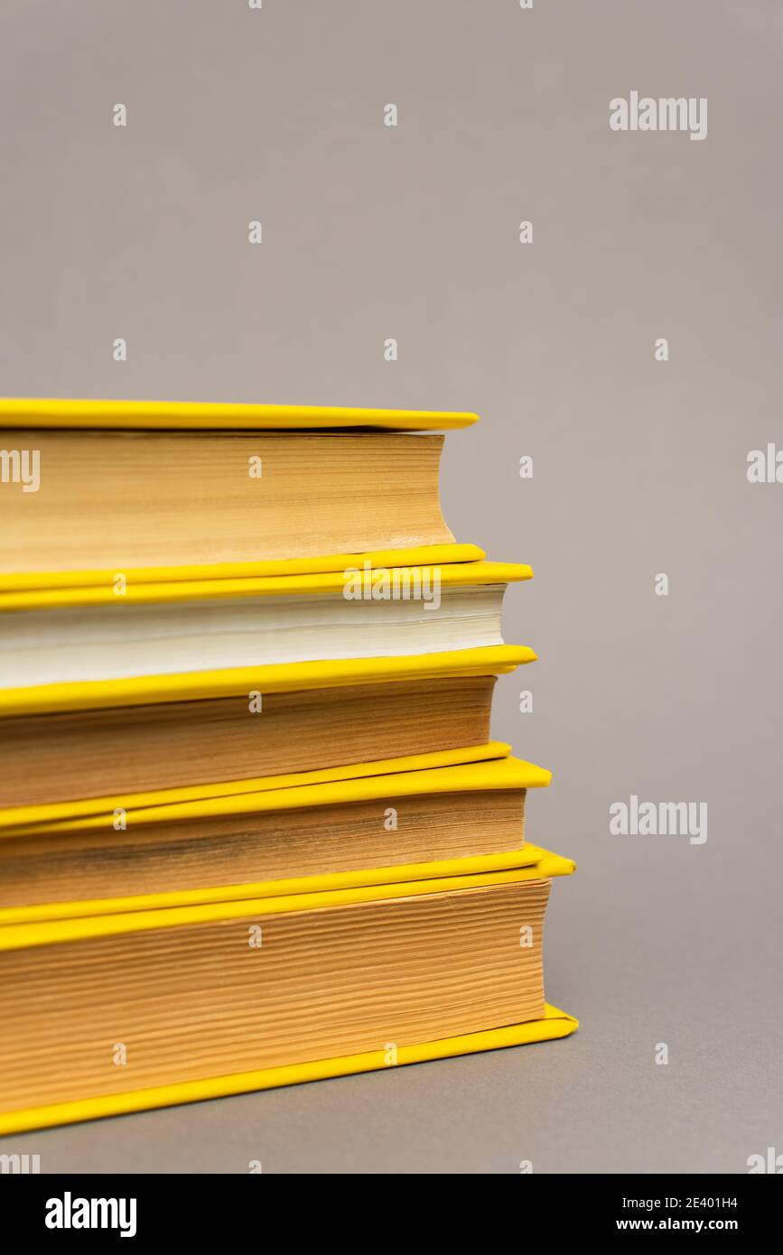 stack of yellow notebooks isolated on grey Stock Photo - Alamy
