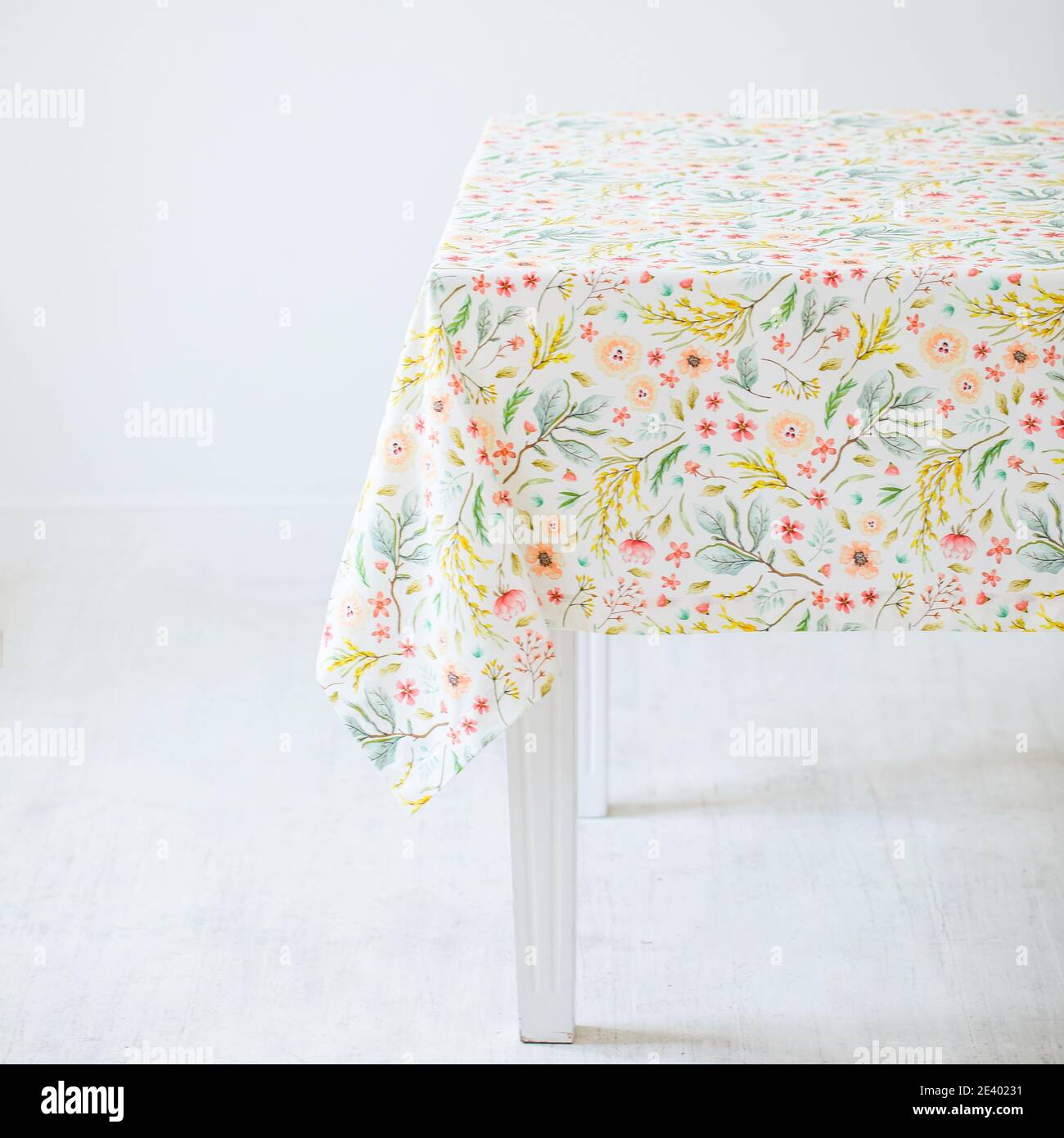 Decorative tablecloth with floral patterns on a table on a white ...