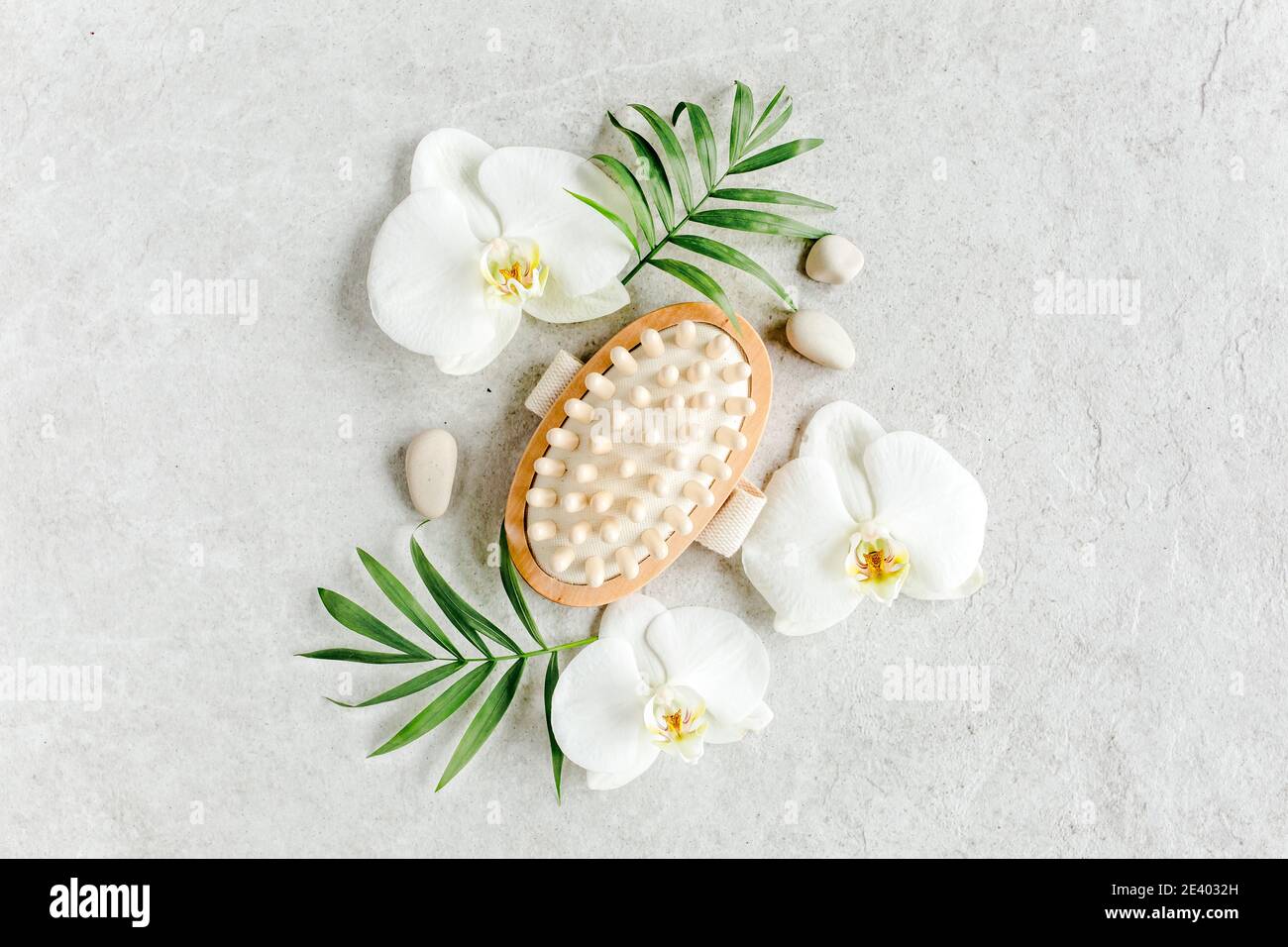 Spa treatment concept. Natural spa cosmetics products, sea salt, massage brush, tropic palm ...