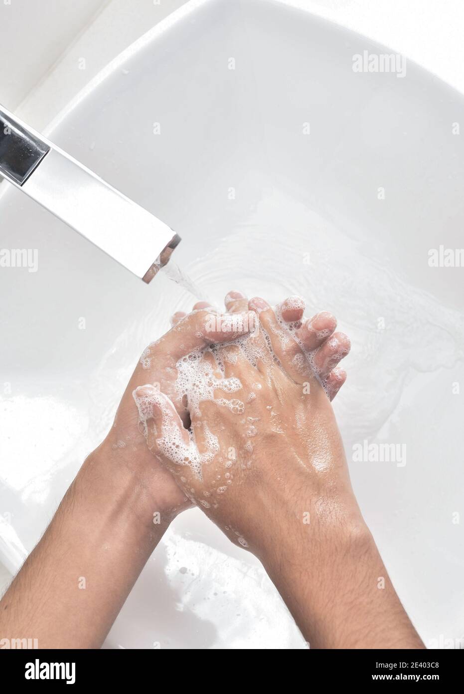 Vertical top view of hands with soap near a sink Stock Photo - Alamy