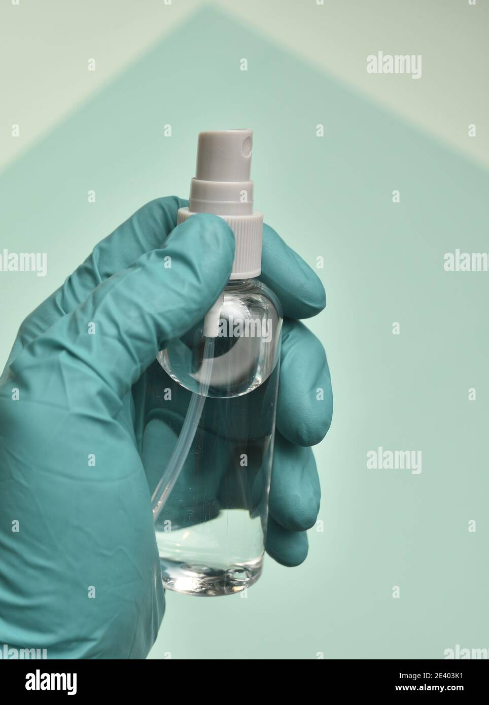 Vertical shot of a gloved hand holding a bottle of sanitizer Stock ...