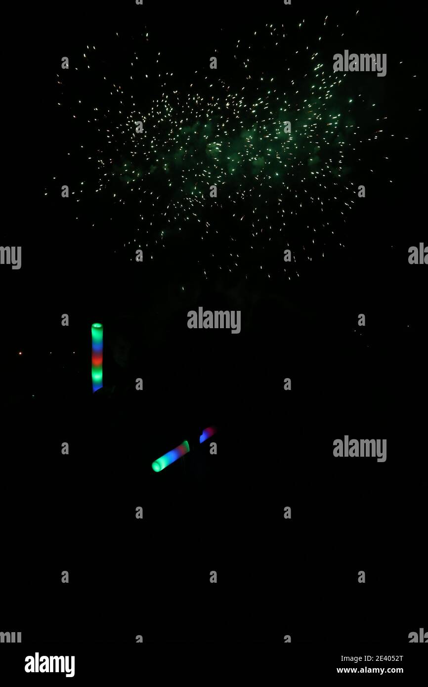 Colourful plastic illumintated wand glow stick in use at fireworks ...