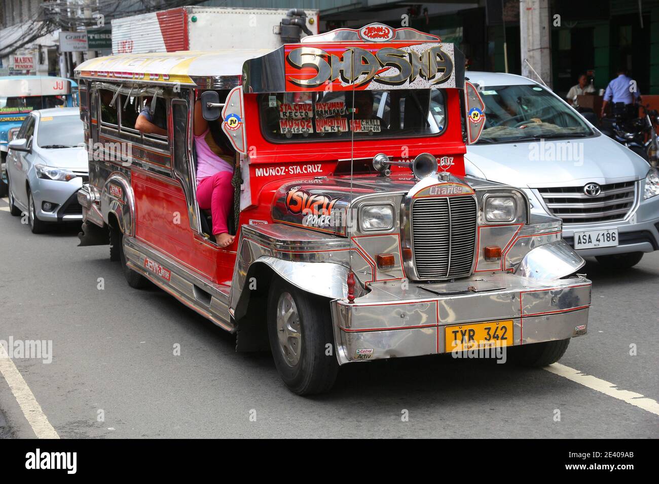 MANILA, PHILIPPINES - NOVEMBER 25, 2017: People ride a jeepney public ...