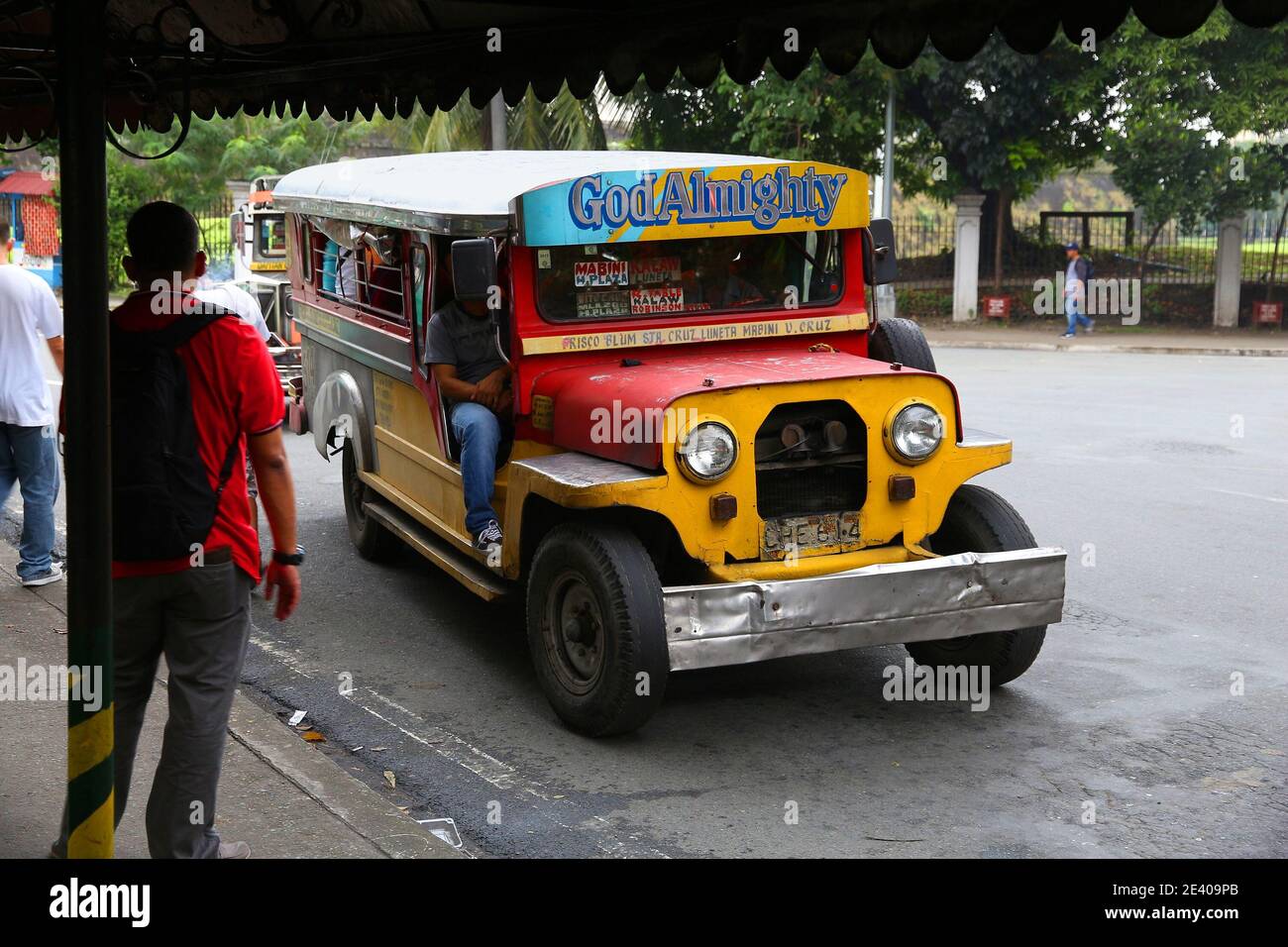 MANILA, PHILIPPINES - NOVEMBER 24, 2017: People ride a jeepney public ...