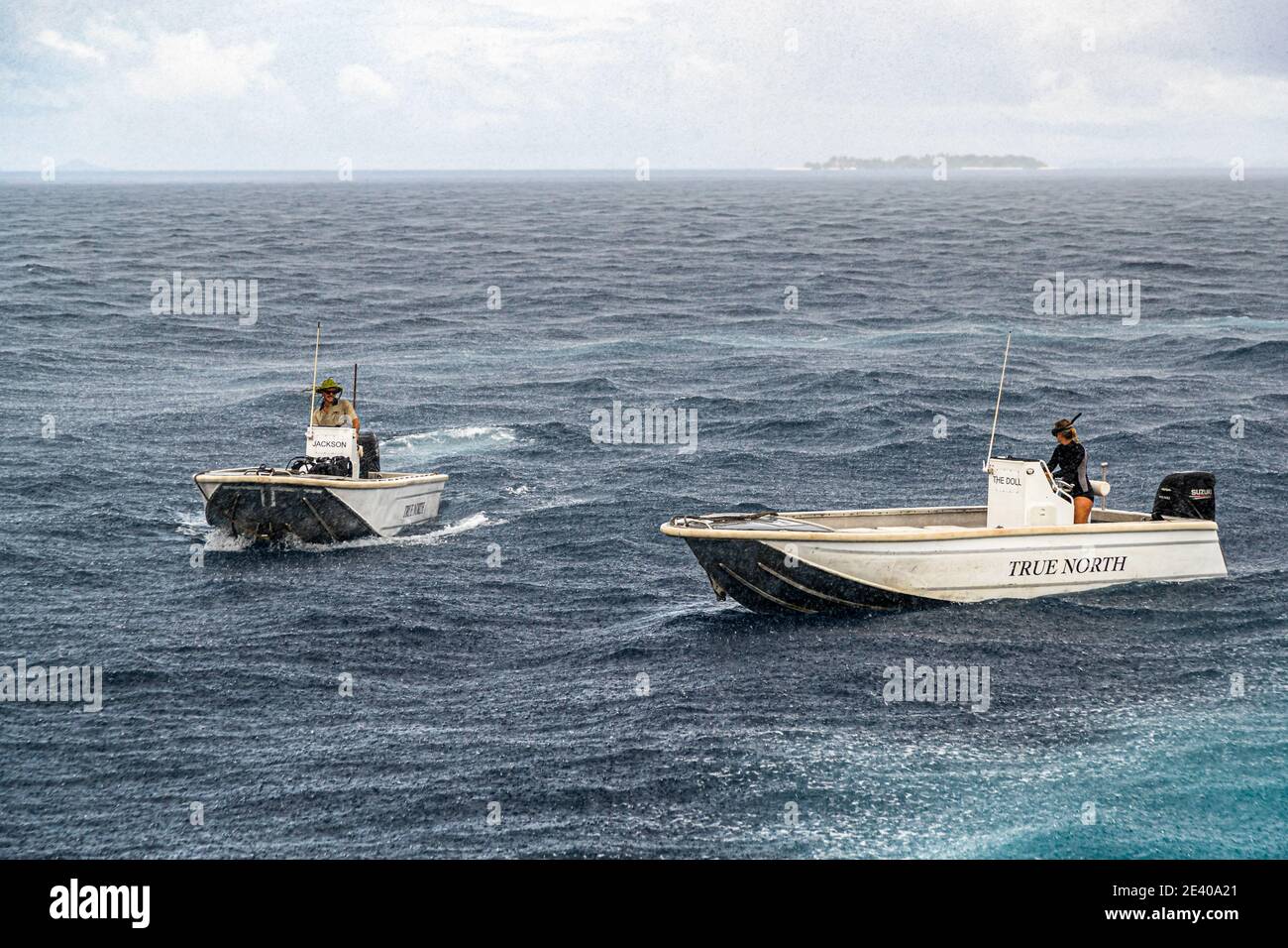 Boat on the ocean in the rain Stock Photo - Alamy