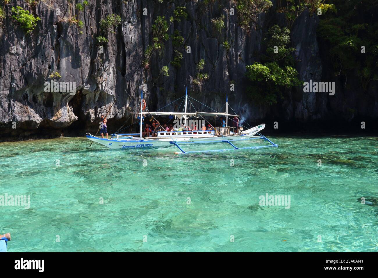 PALAWAN, PHILIPPINES - DECEMBER 1, 2017: Tourists ride outrigger bangka ...