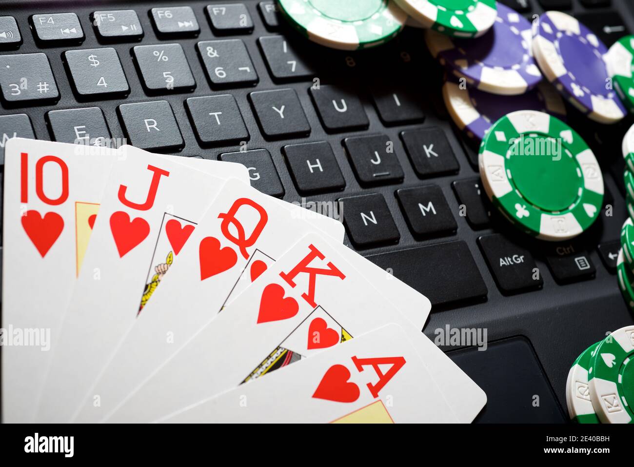 Casino chips and cards stacking on a laptop Stock Photo - Alamy