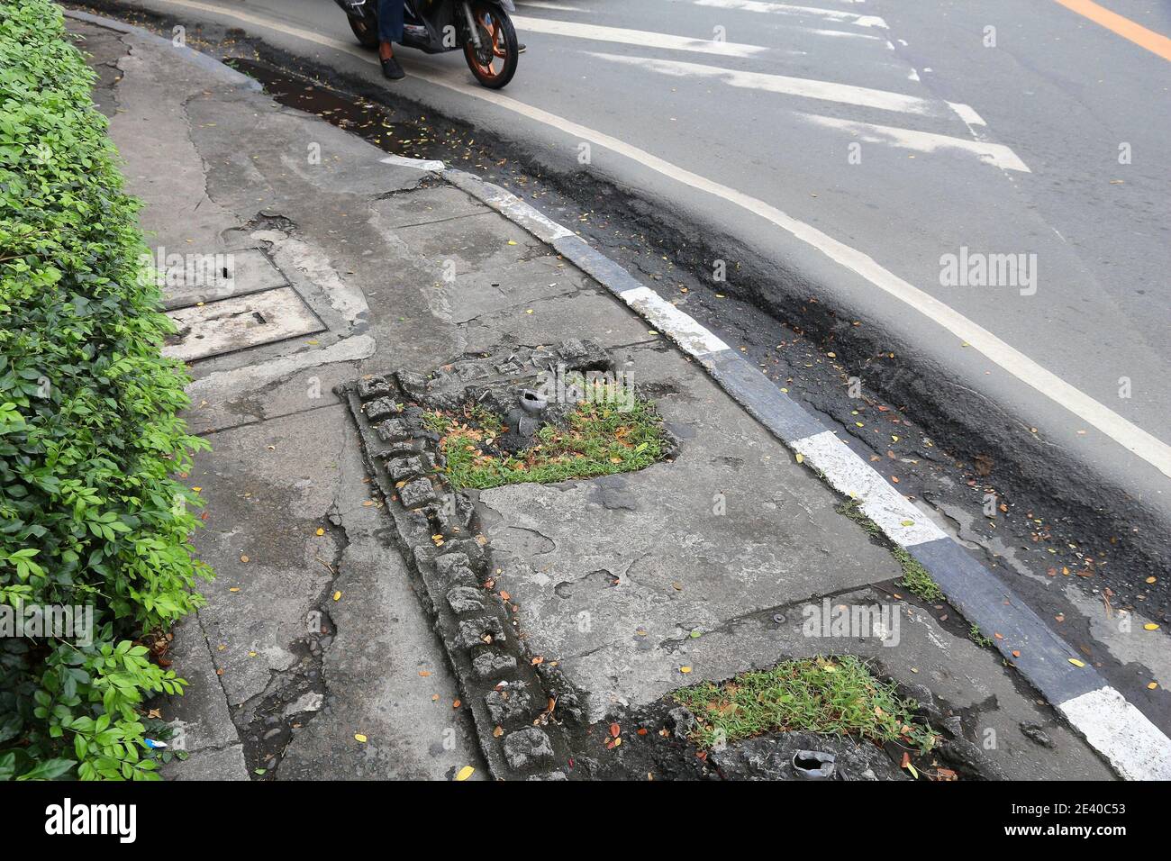 Dangerous uneven city sidewalk in Manila, Philippines. Hazardous holes ...