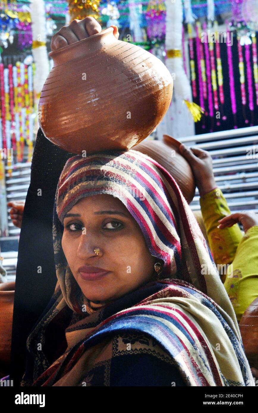 Lahore, Pakistan. 20th Jan, 2021. Pakistani women devotees bringing ...