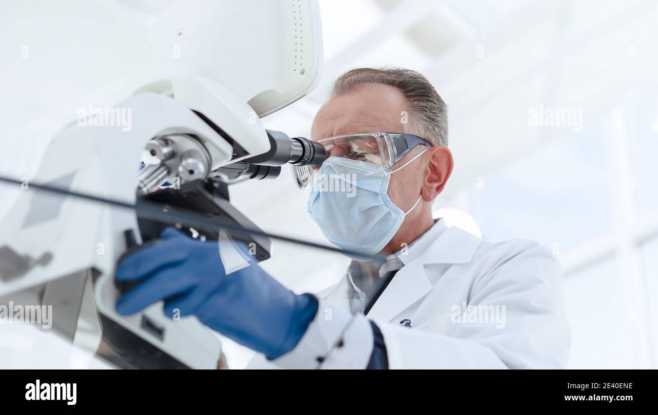 close up. a serious scientist using a laboratory microscope Stock Photo ...
