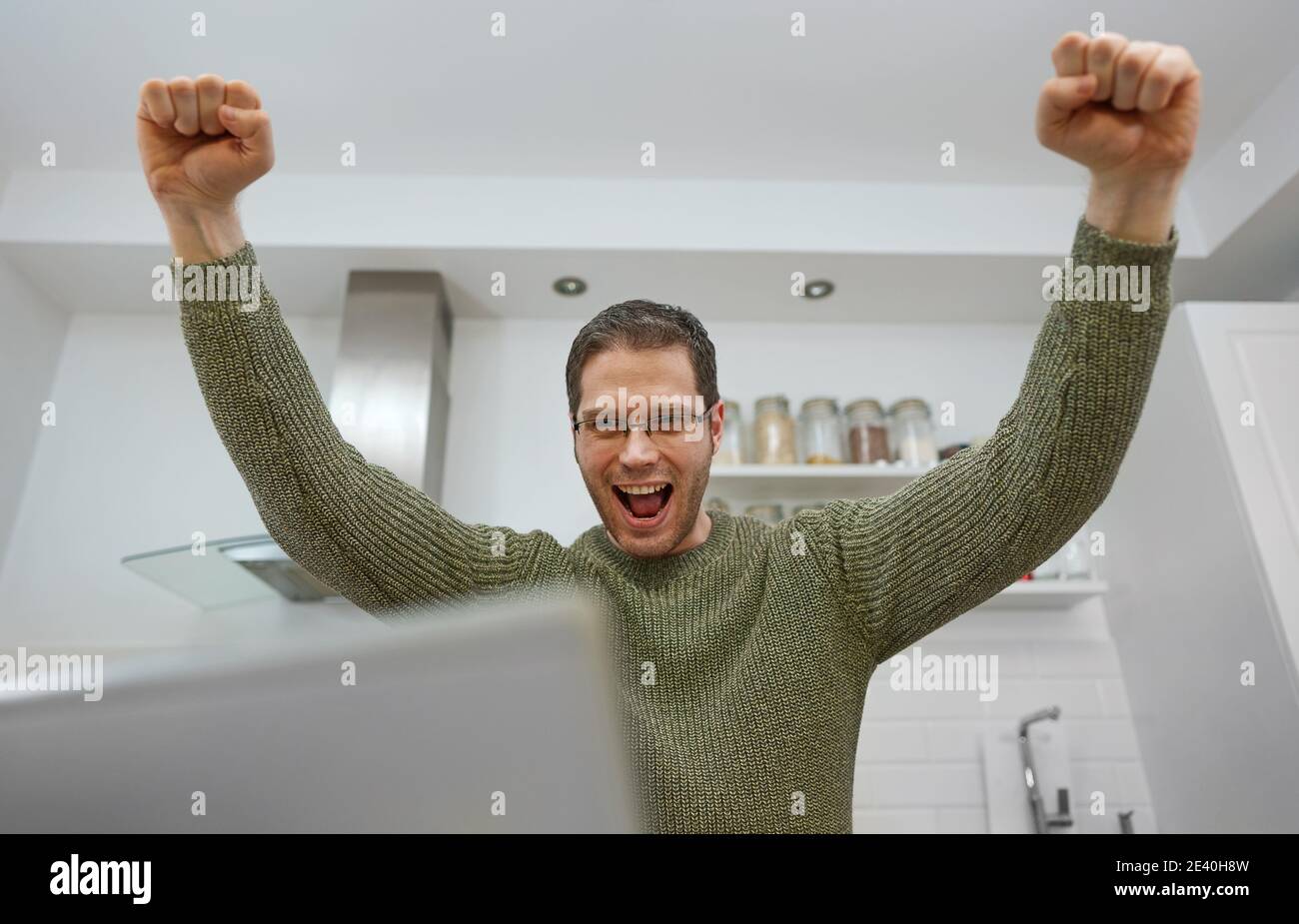 Excited man with laptop. Online gaming concept Stock Photo - Alamy