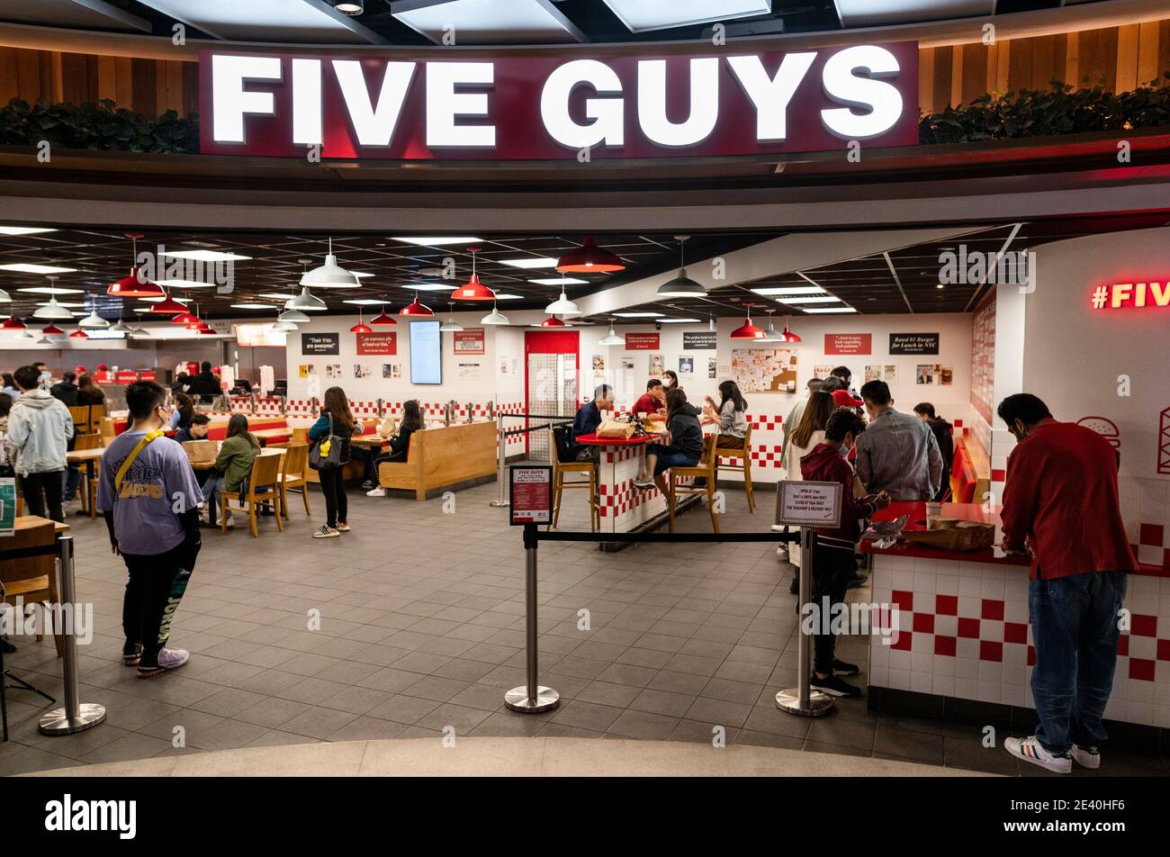 Customers eat at the American fast casual restaurant chain Five Guys in ...