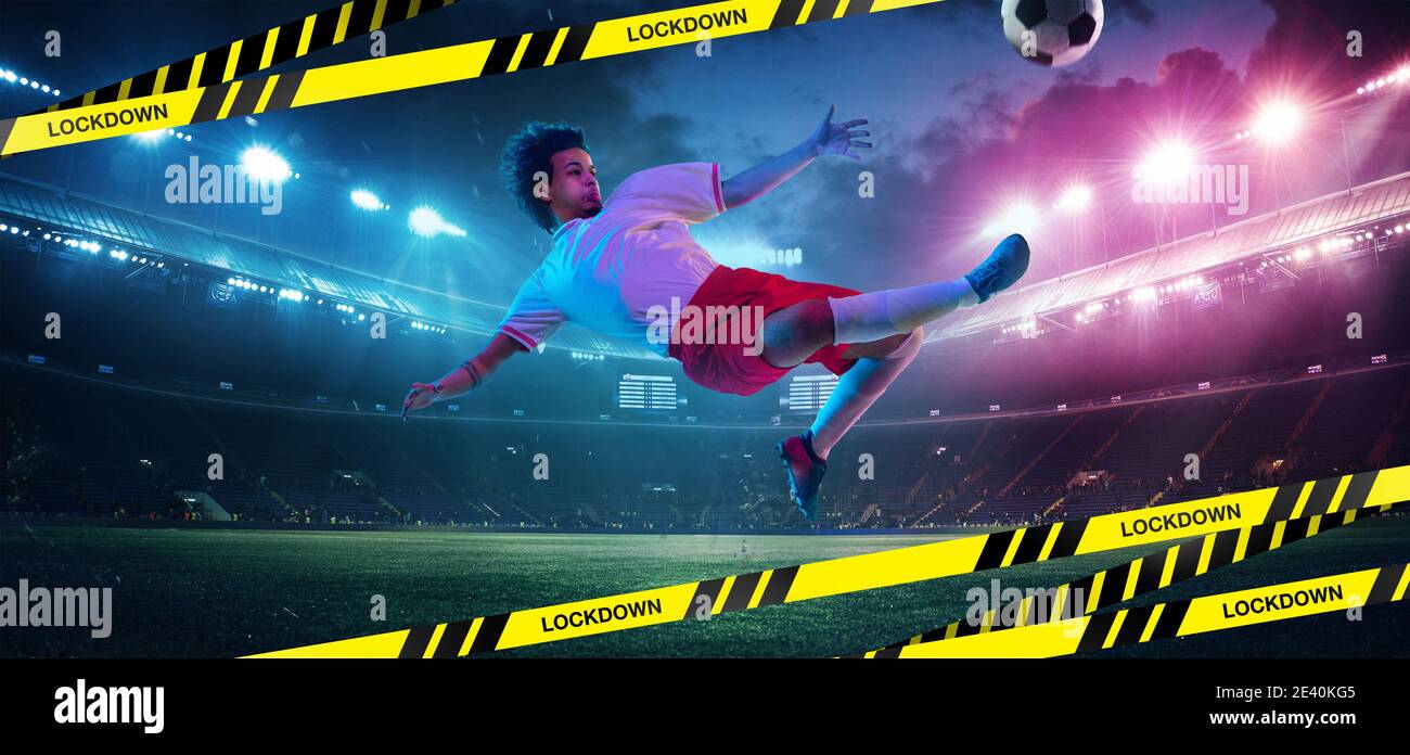 Football or soccer player on stadium background behind limiting tapes ...
