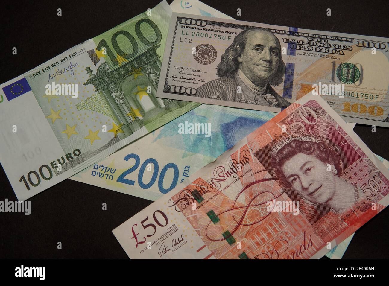 Flat Lay Of Euro GBP Israeli Shekel And Dollar Banknotes On A Black flat-lay-of-euro-gbp-israeli-shekel-and-dollar-banknotes-on-a-black