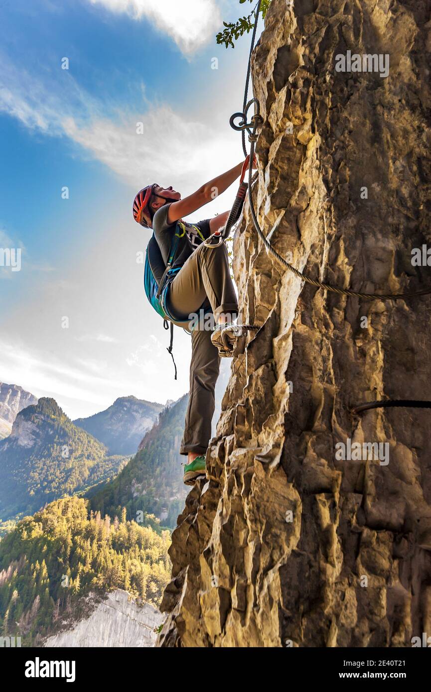 Via ferrata in Mont-Sixt-Fer-a-Cheval (French Alps). Young woman on via ...