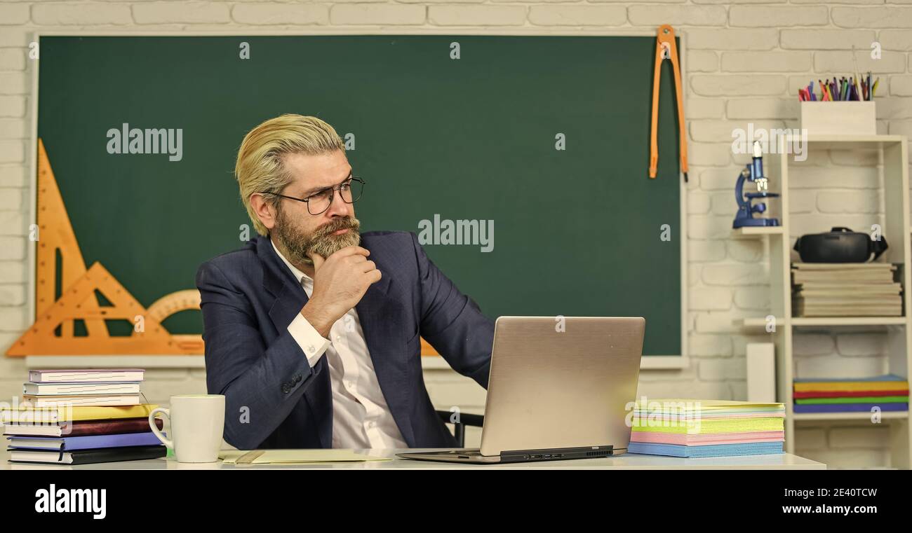 Lost in thoughts. Serious man back to school. Senior teacher look ...