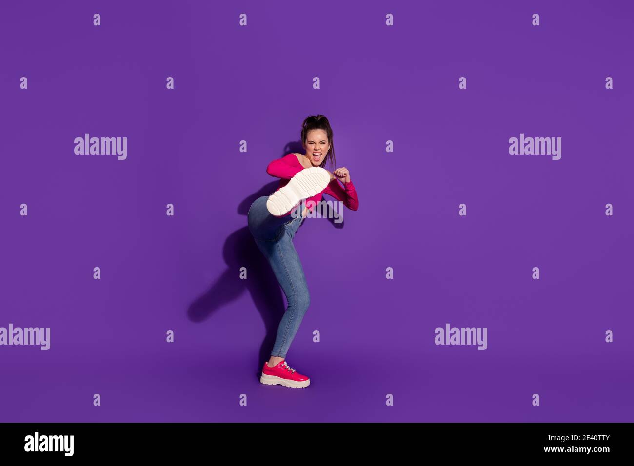 Full length body size view of strong cheerful girl fighting invisible ...