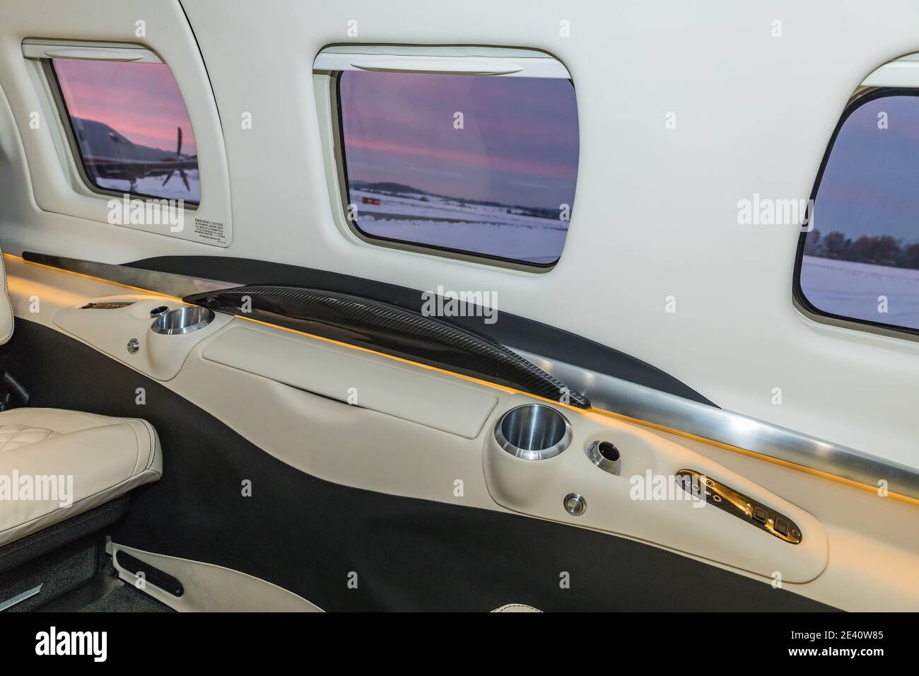 Modern interior of a sports aircraft illuminated by dim light. View ...