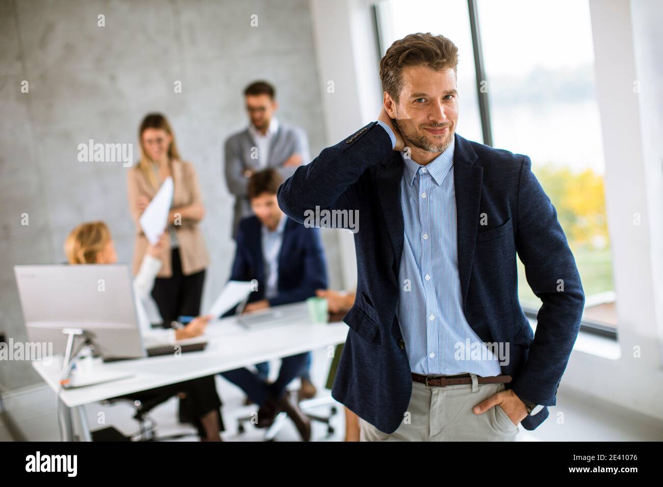 Handsome young business man standing hi-res stock photography and ...