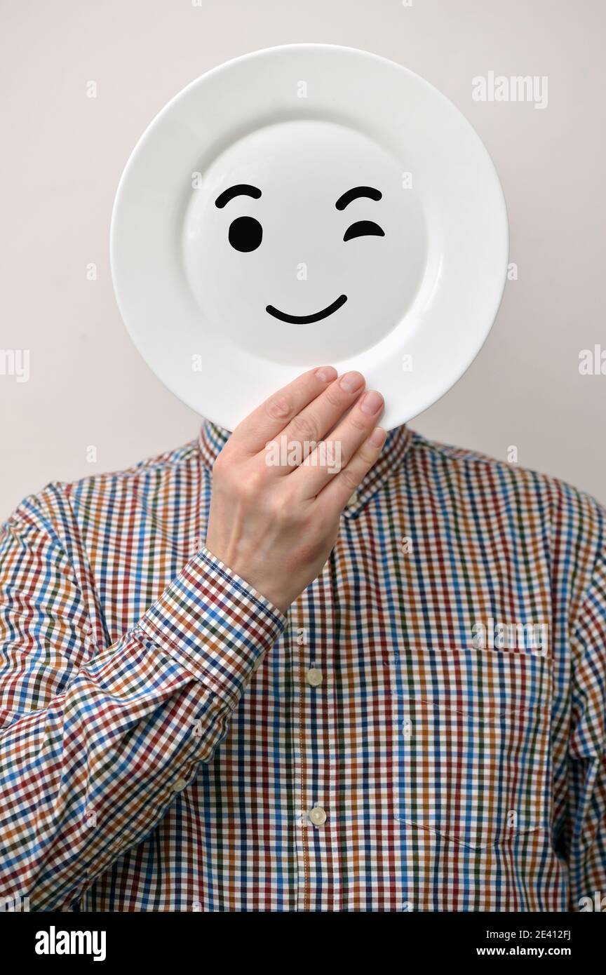 Conceptual Man Happy Face from empty Plate and Emoticon Stock Photo - Alamy