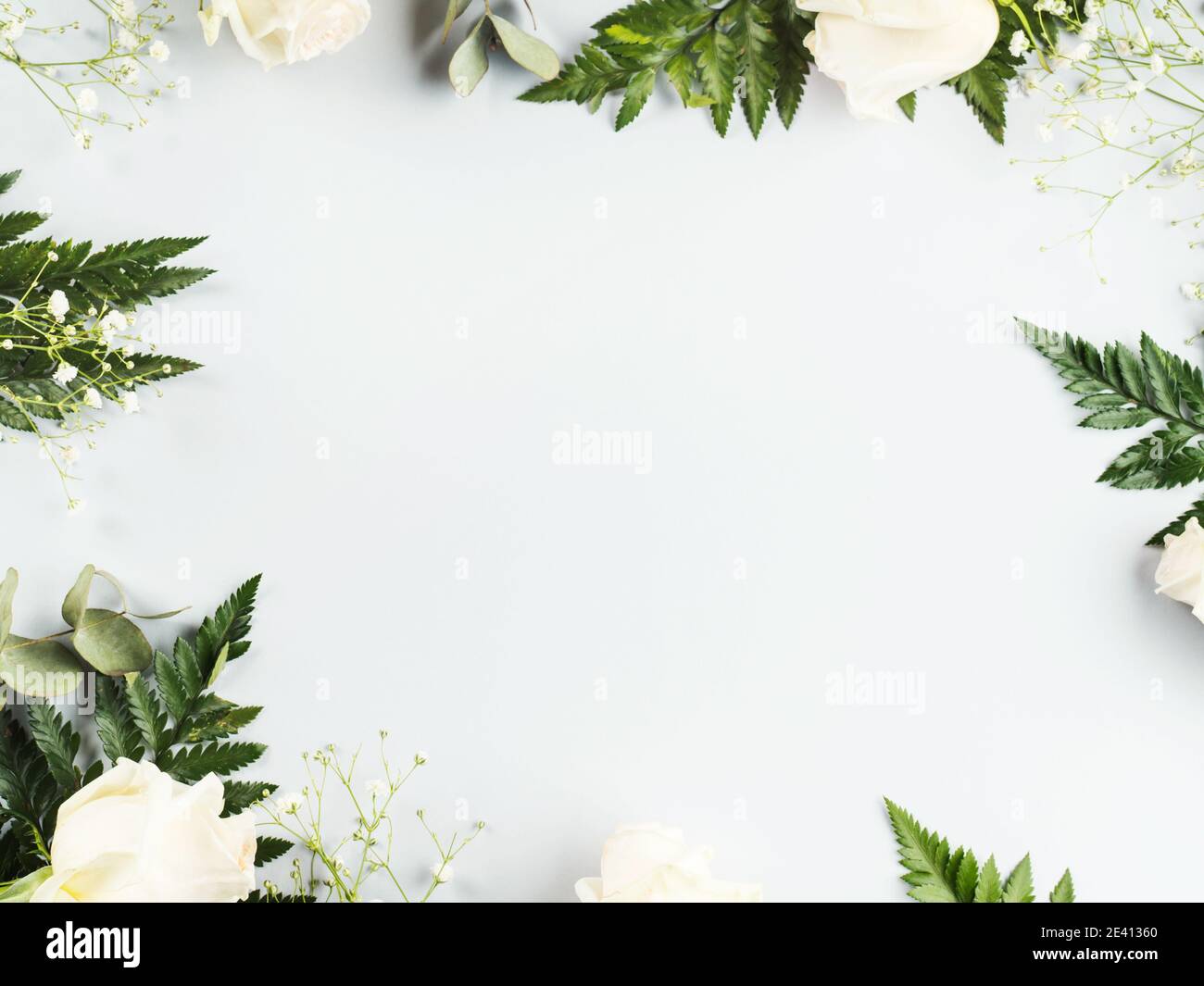 Floral arrangement frame with white roses and fern Stock Photo - Alamy