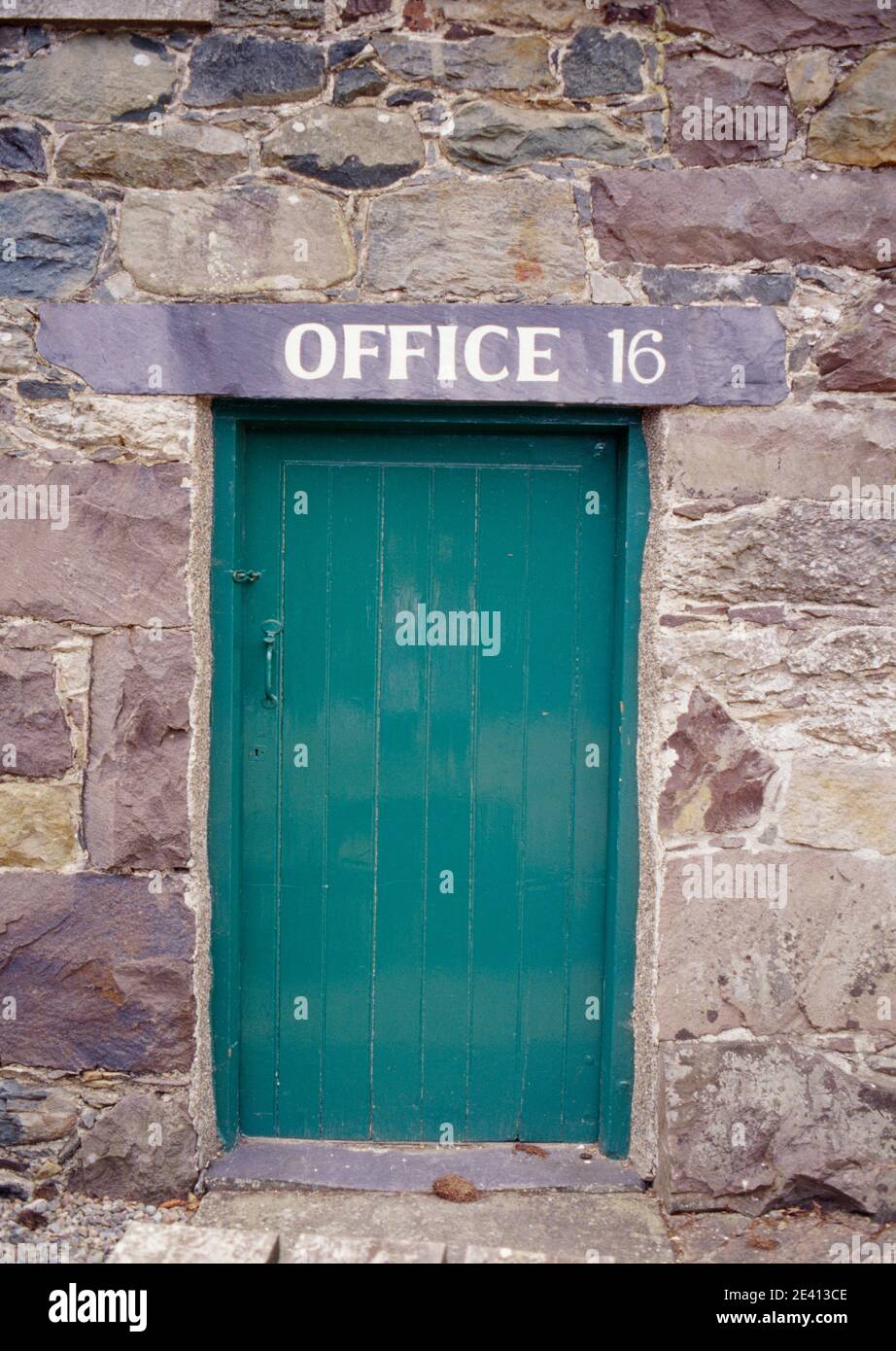 Estate yard built from very large stone masonry. Detailed boarded door ...