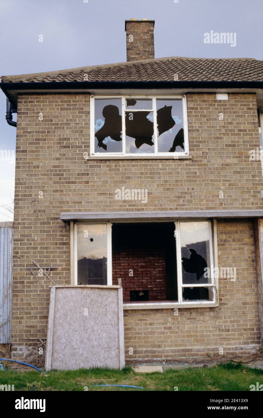 Windows smashed in brick house, stoke newington london Stock Photo - Alamy