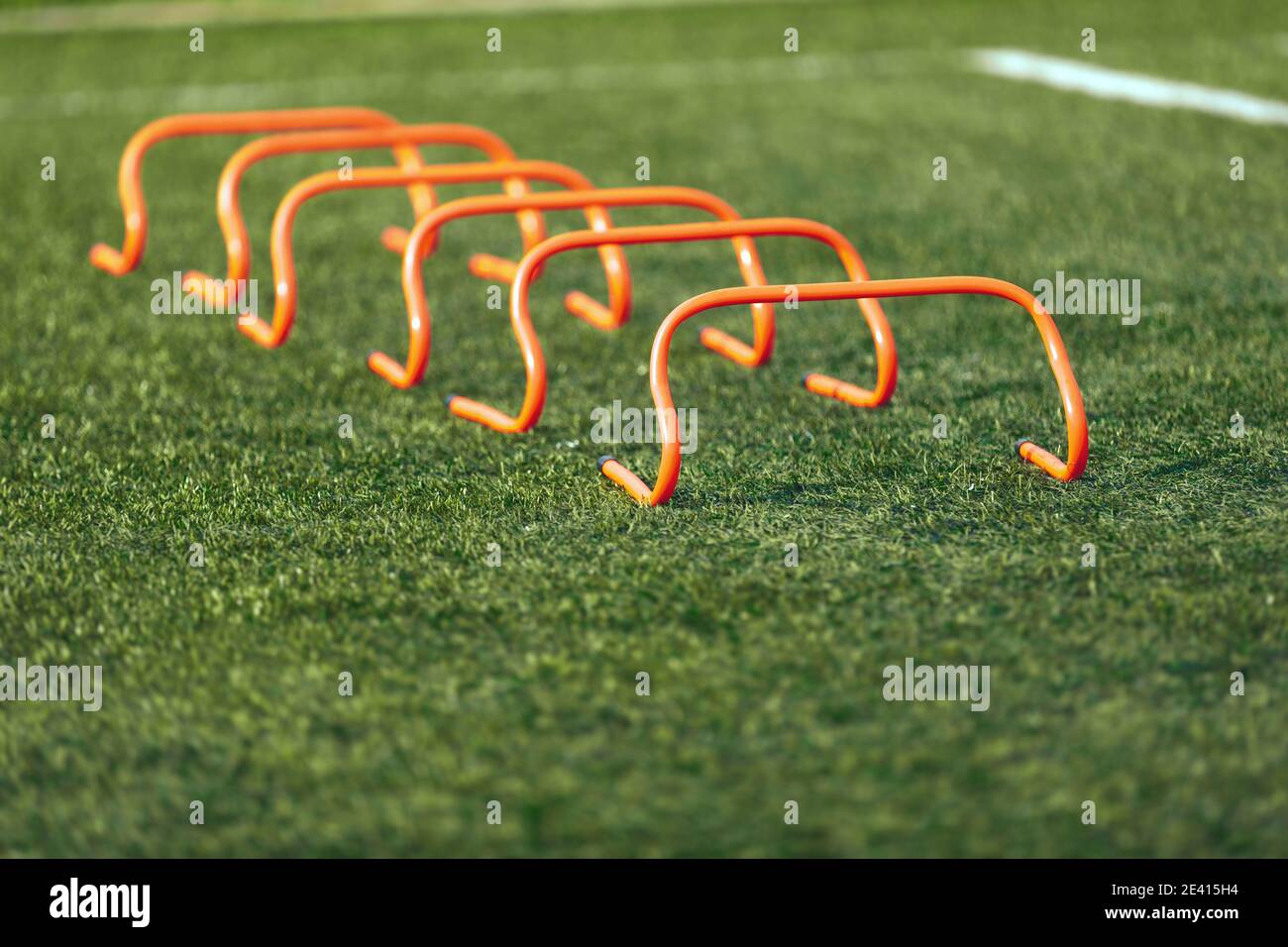 Set of soccer hurdles. Orange football hurdles training. Grass practice ...